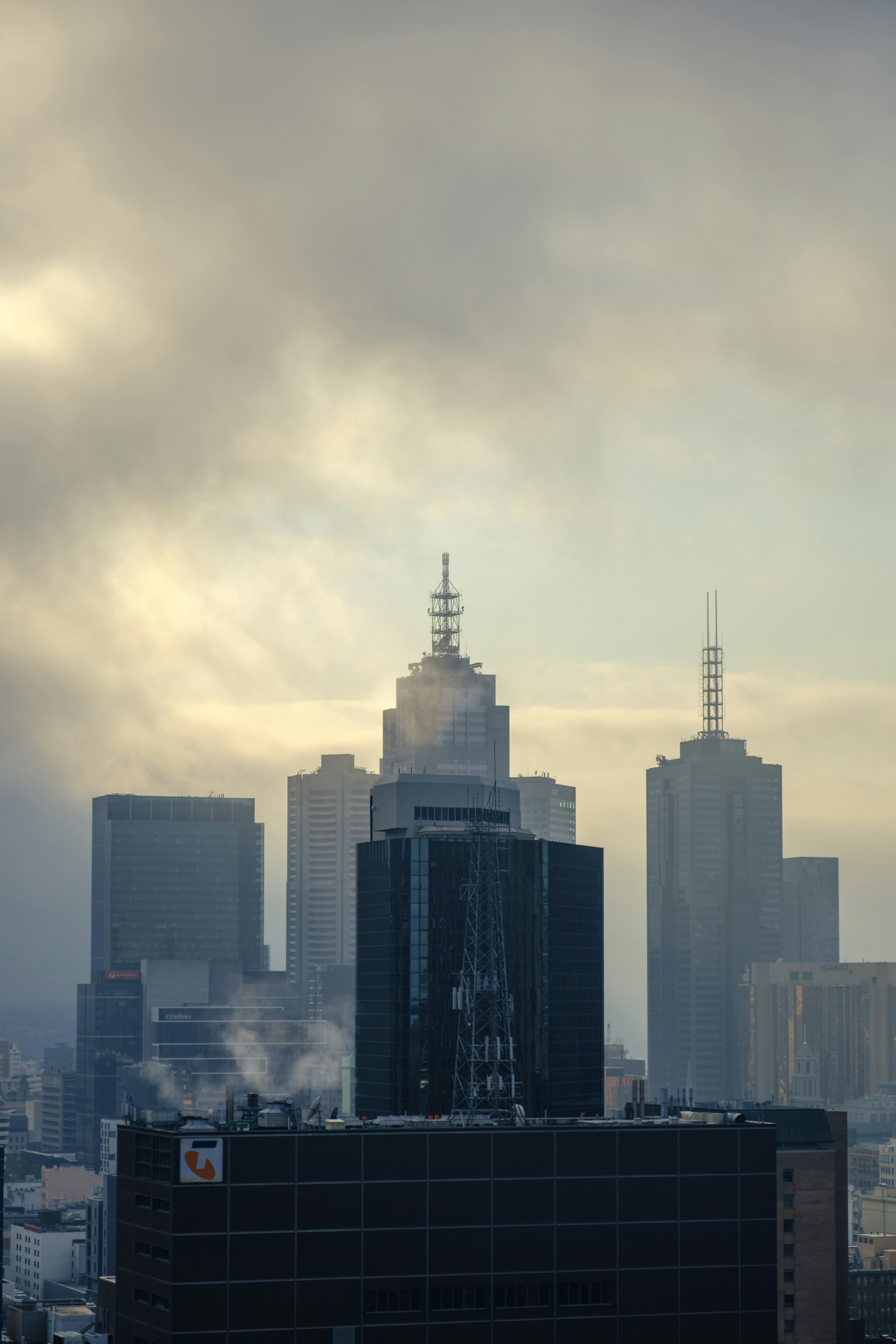 city skyline under white clouds during daytime