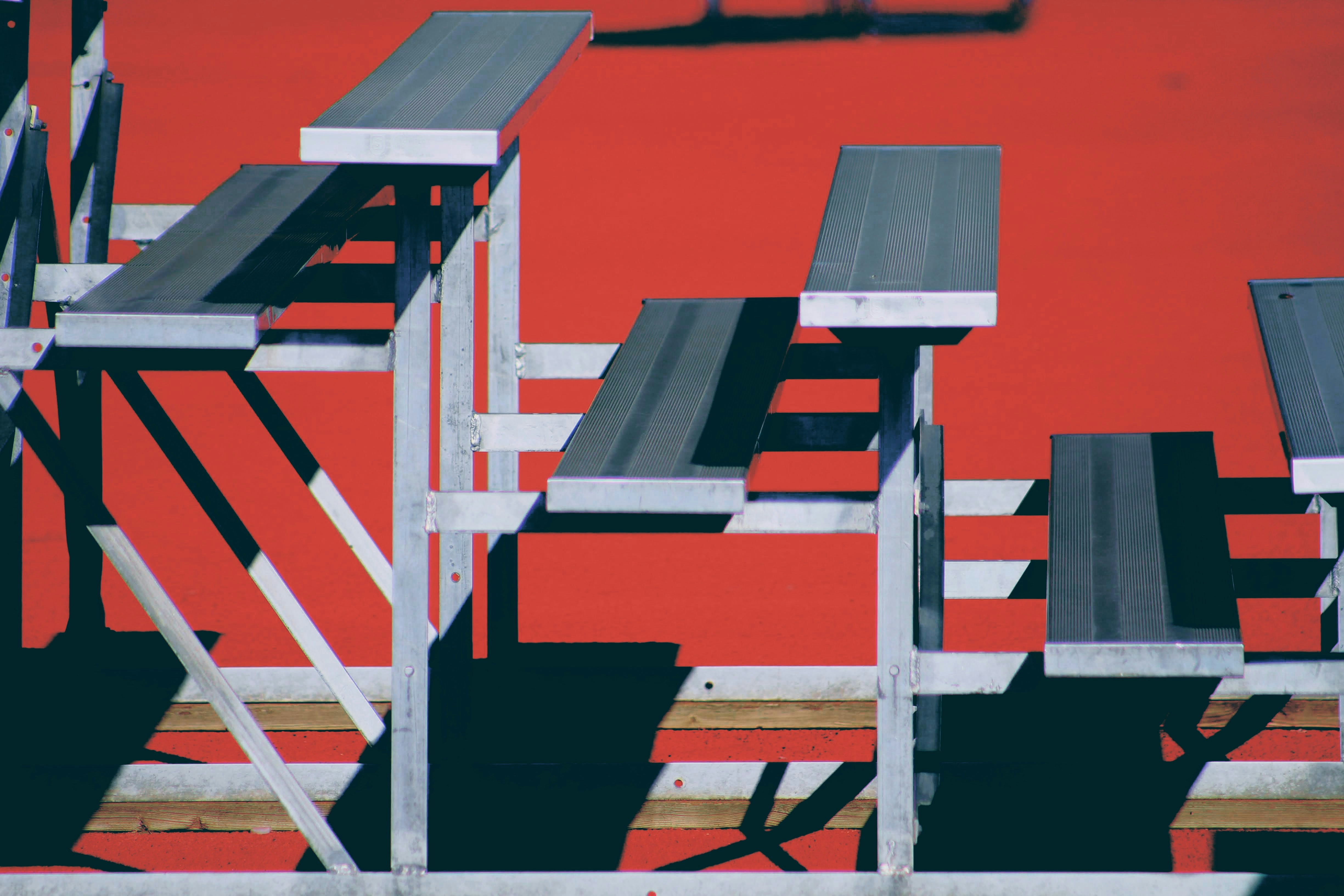Crimson Backdrop, White Ribs: A Study in Geometric Bleachers