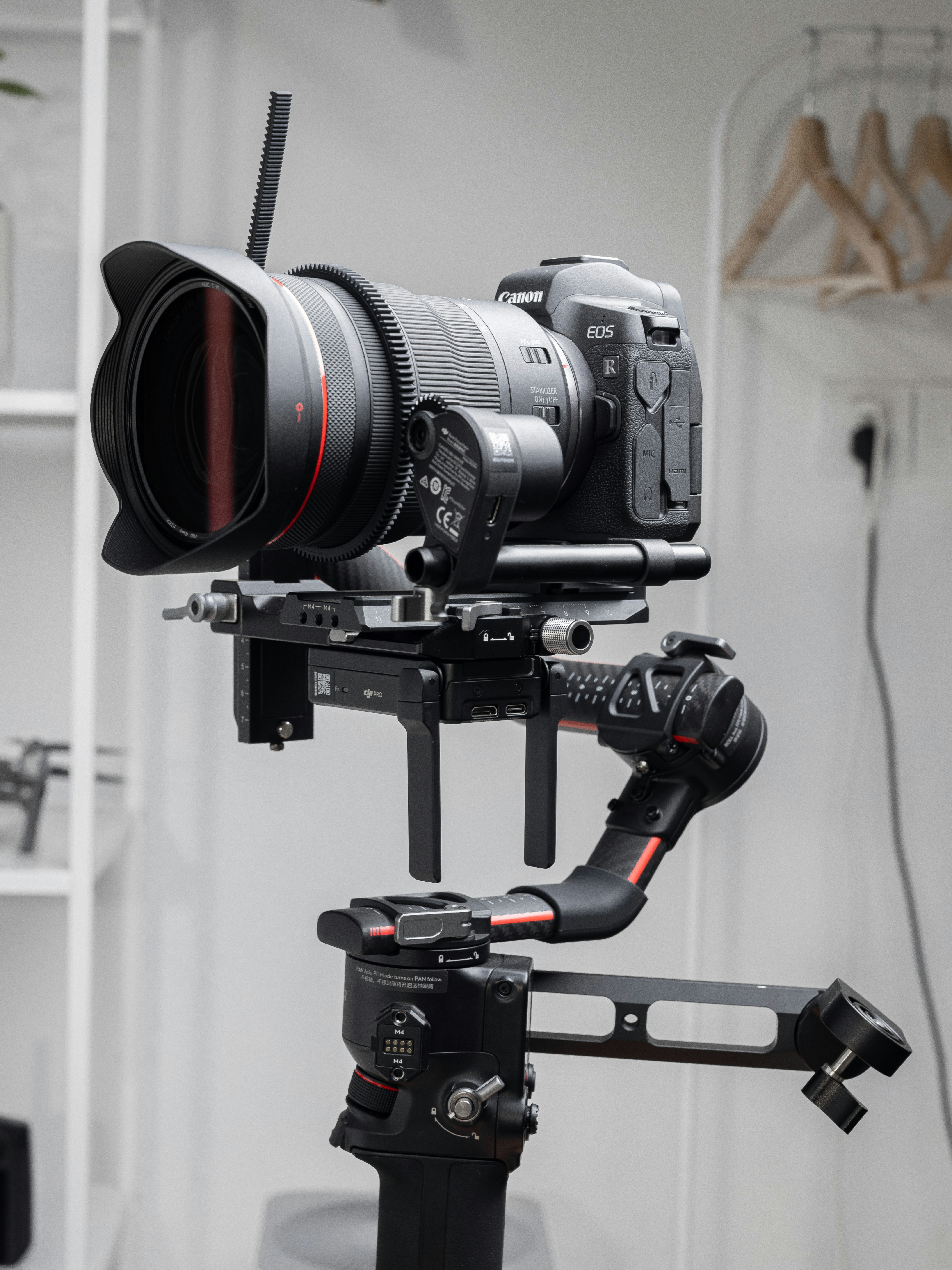 Canon EOS R mounted on a professional gimbal, showcasing advanced stabilization technology in a minimalistic studio setup.