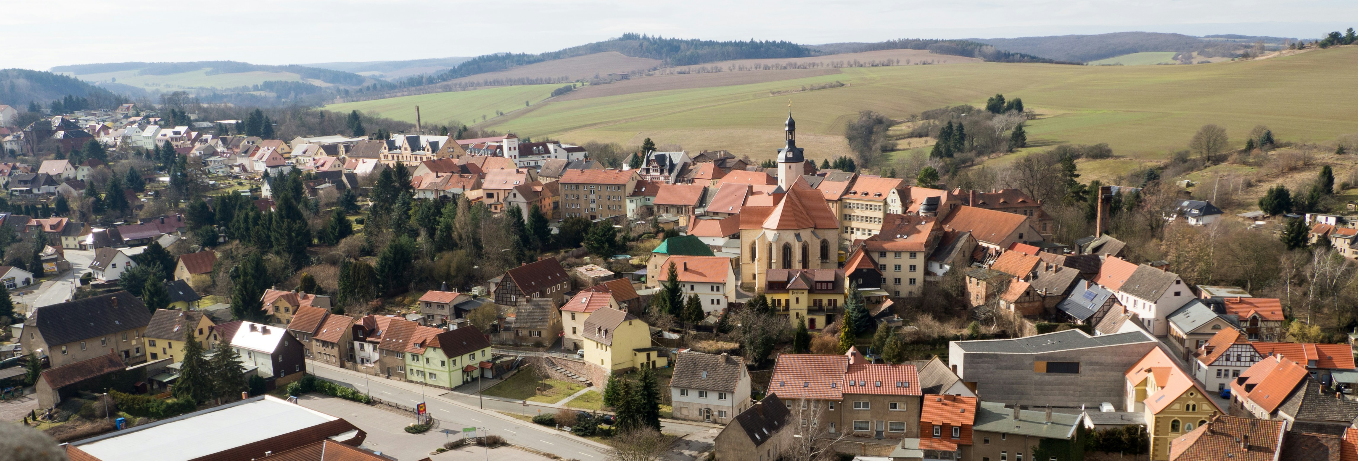 Harmonious Hilltown: A Quiet Arc of Roofs and Steeple