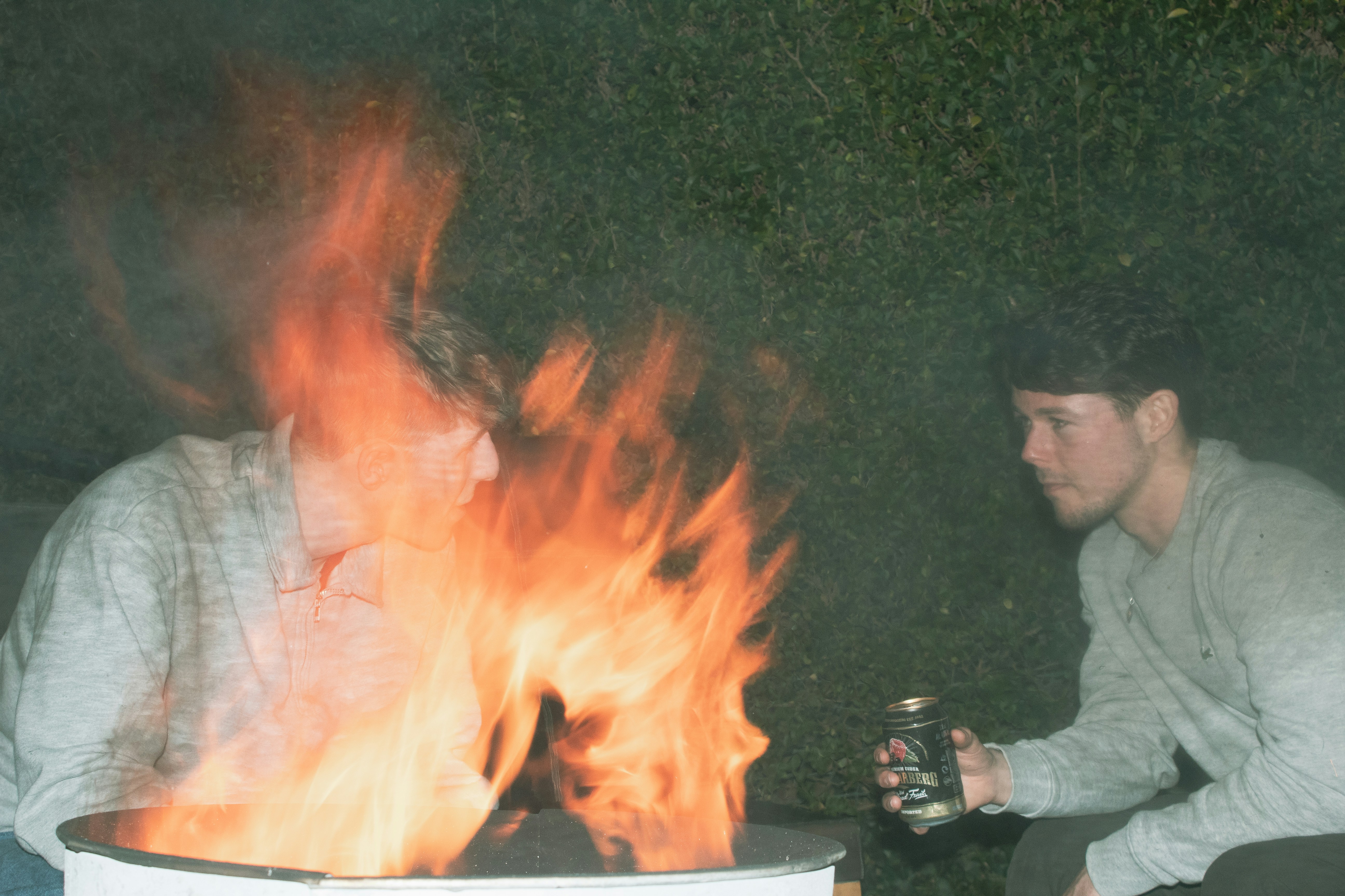 man in white dress shirt smoking cigarette during night time
