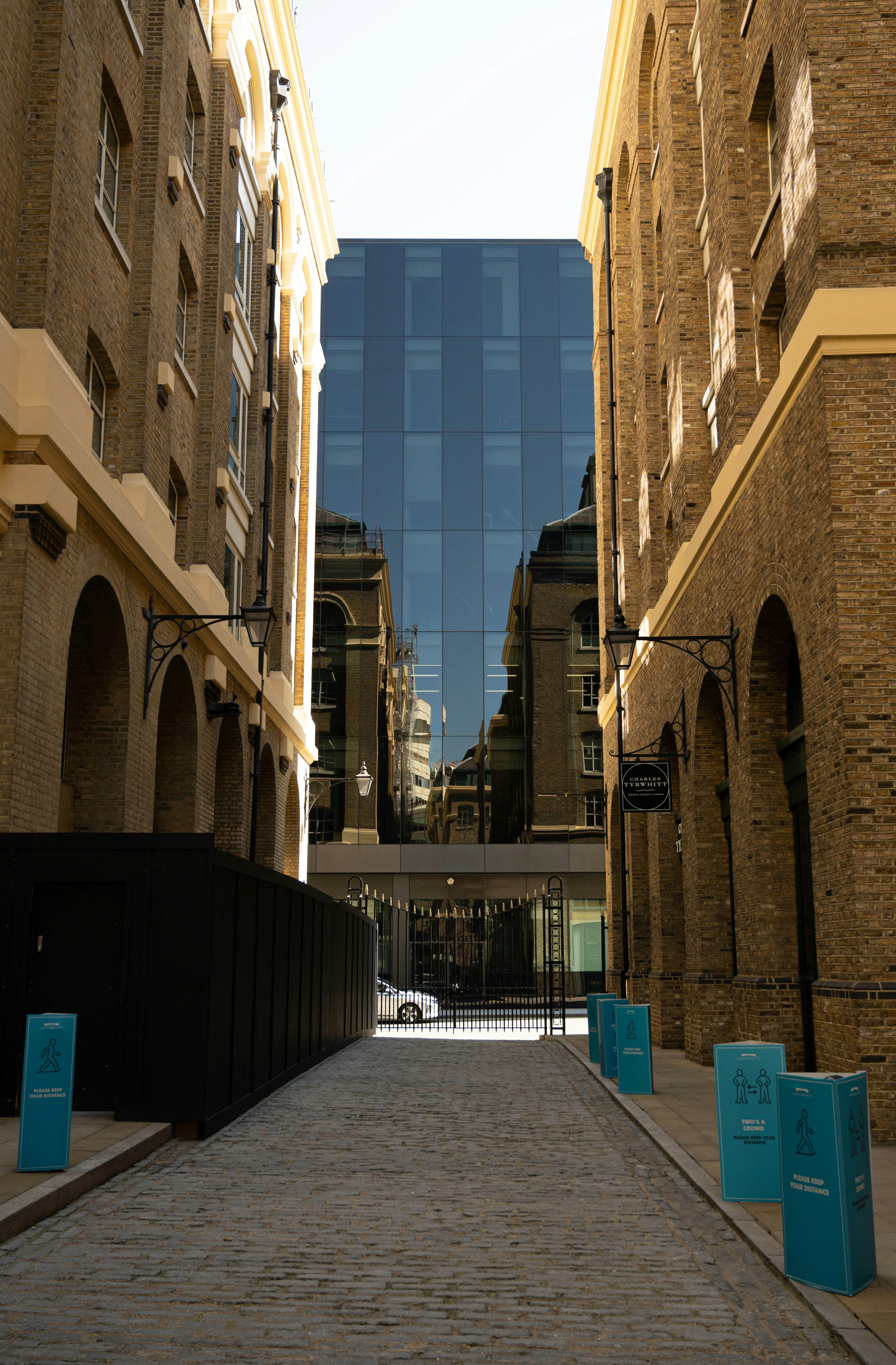 Urban Alleyway Leading to a Glass Facade Tower