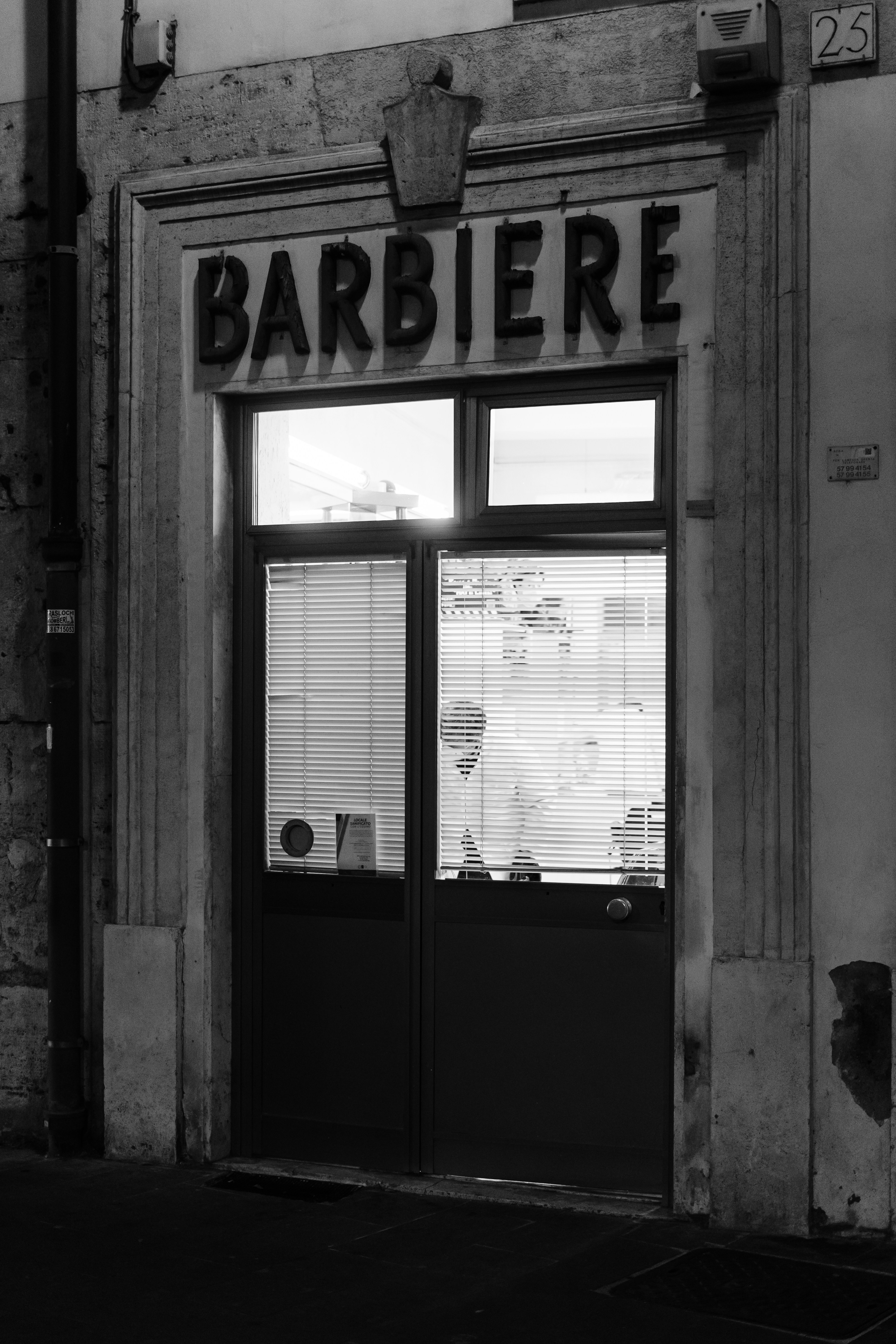 Barbiere at Dusk: A Quiet Threshold Behind Blinds
