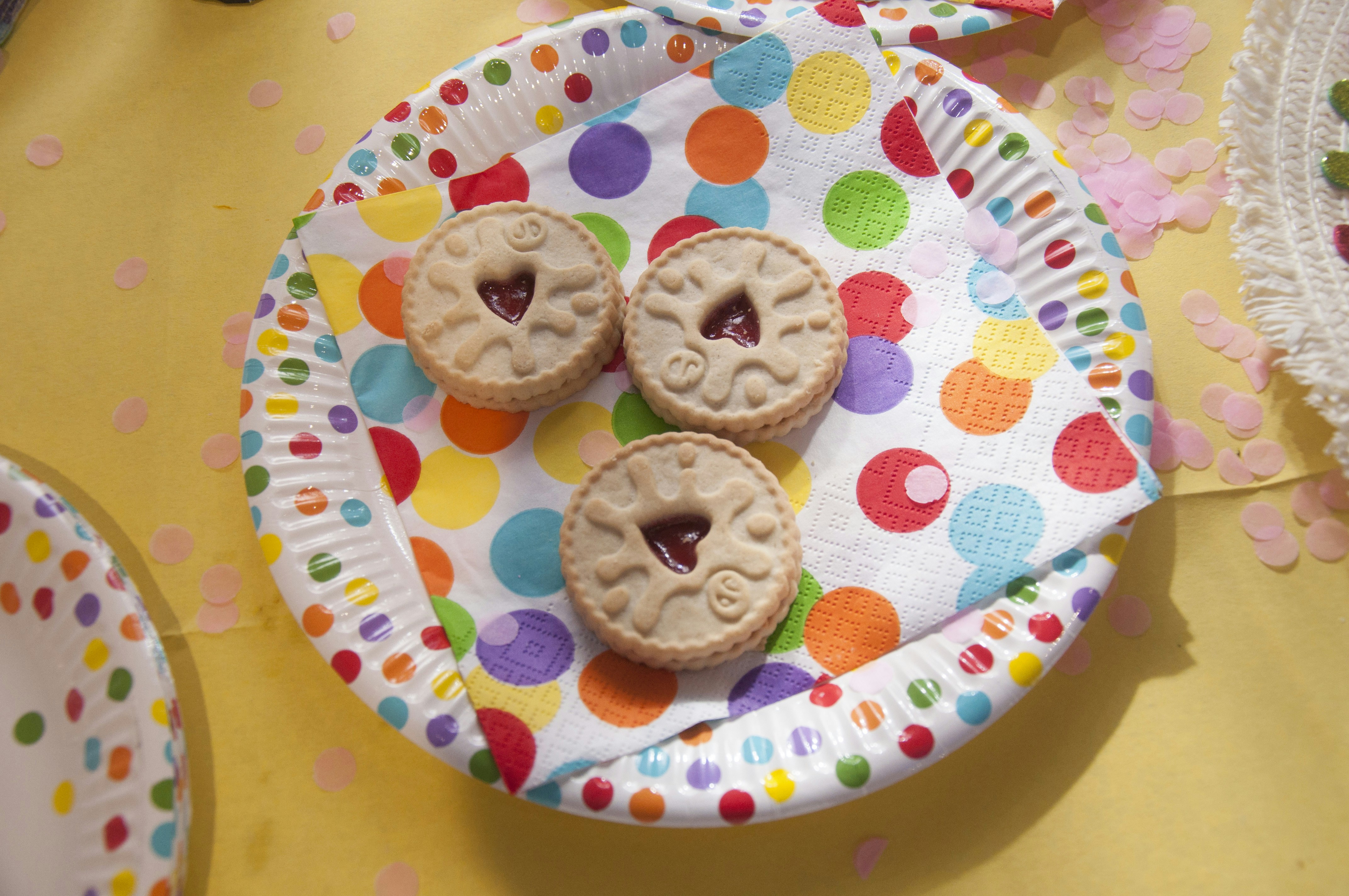 Three Heart-Filled Cookies Anchored on a Colorful Party Plate