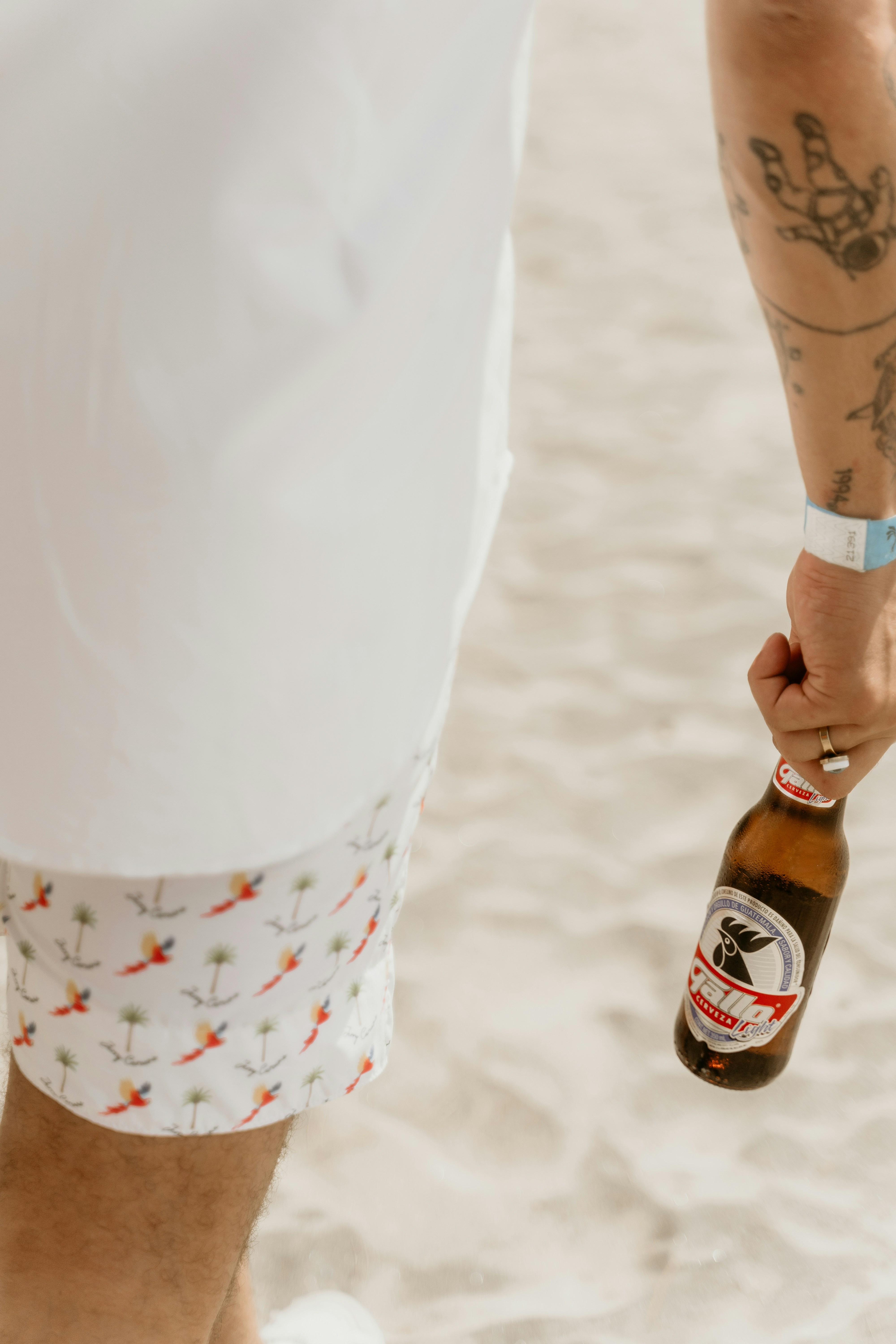 Bottle in Hand at the Beach: A Casual Moment frozen in sunlight
