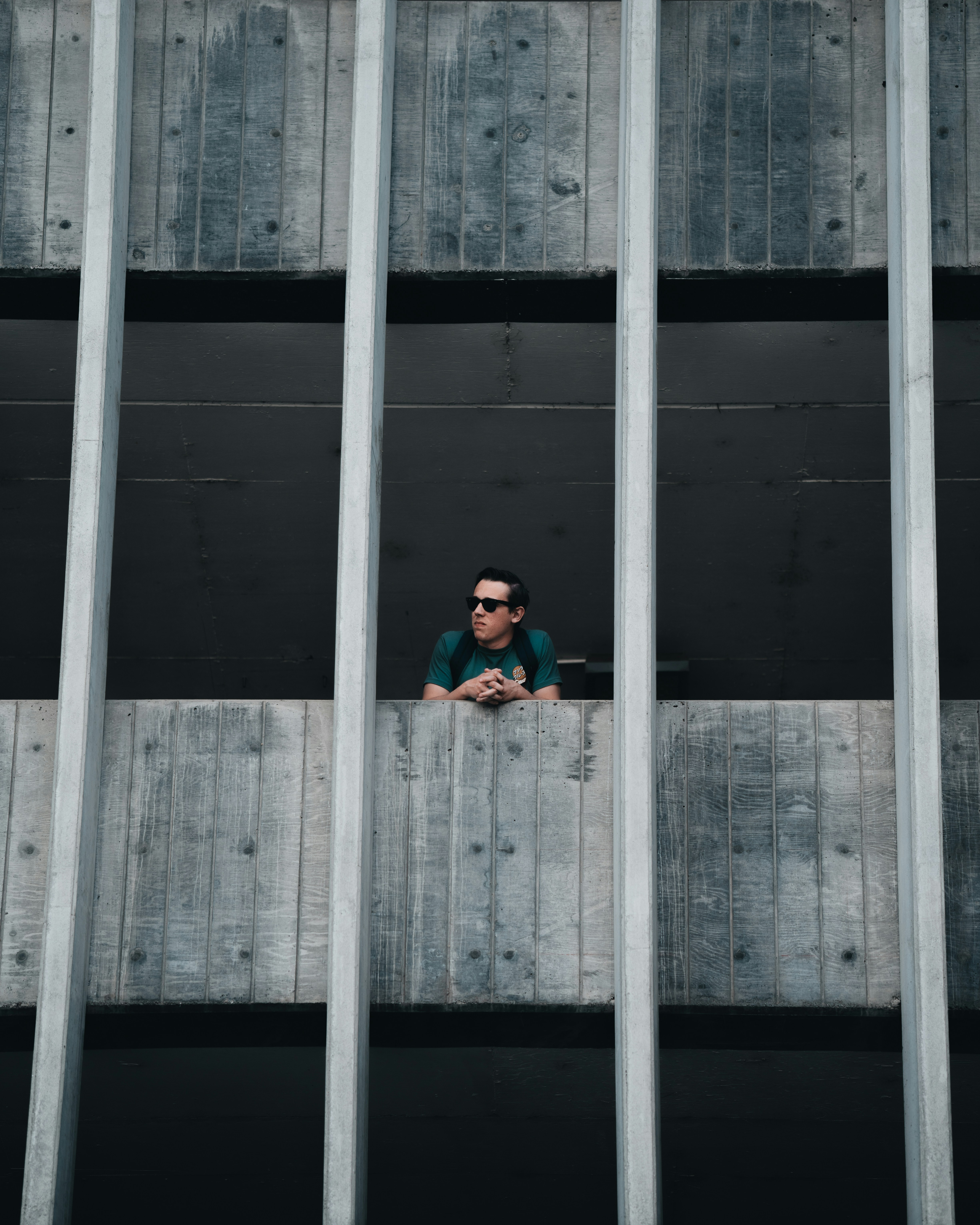Between Concrete Beams: A Quiet Balcony Moment