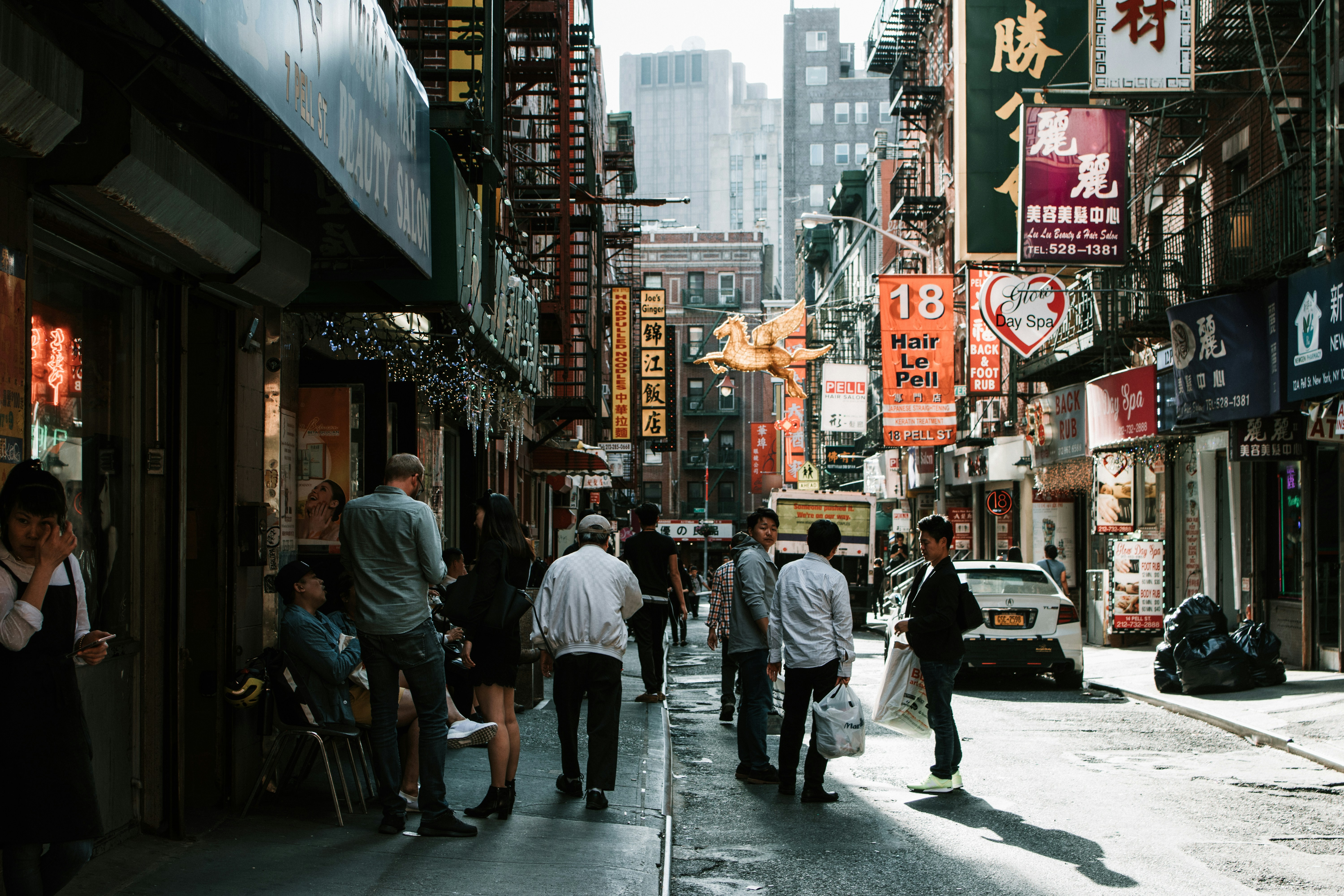 Bustling Chinatown street scene filled with pedestrians and vibrant signage, capturing the essence of urban life and cultural diversity.