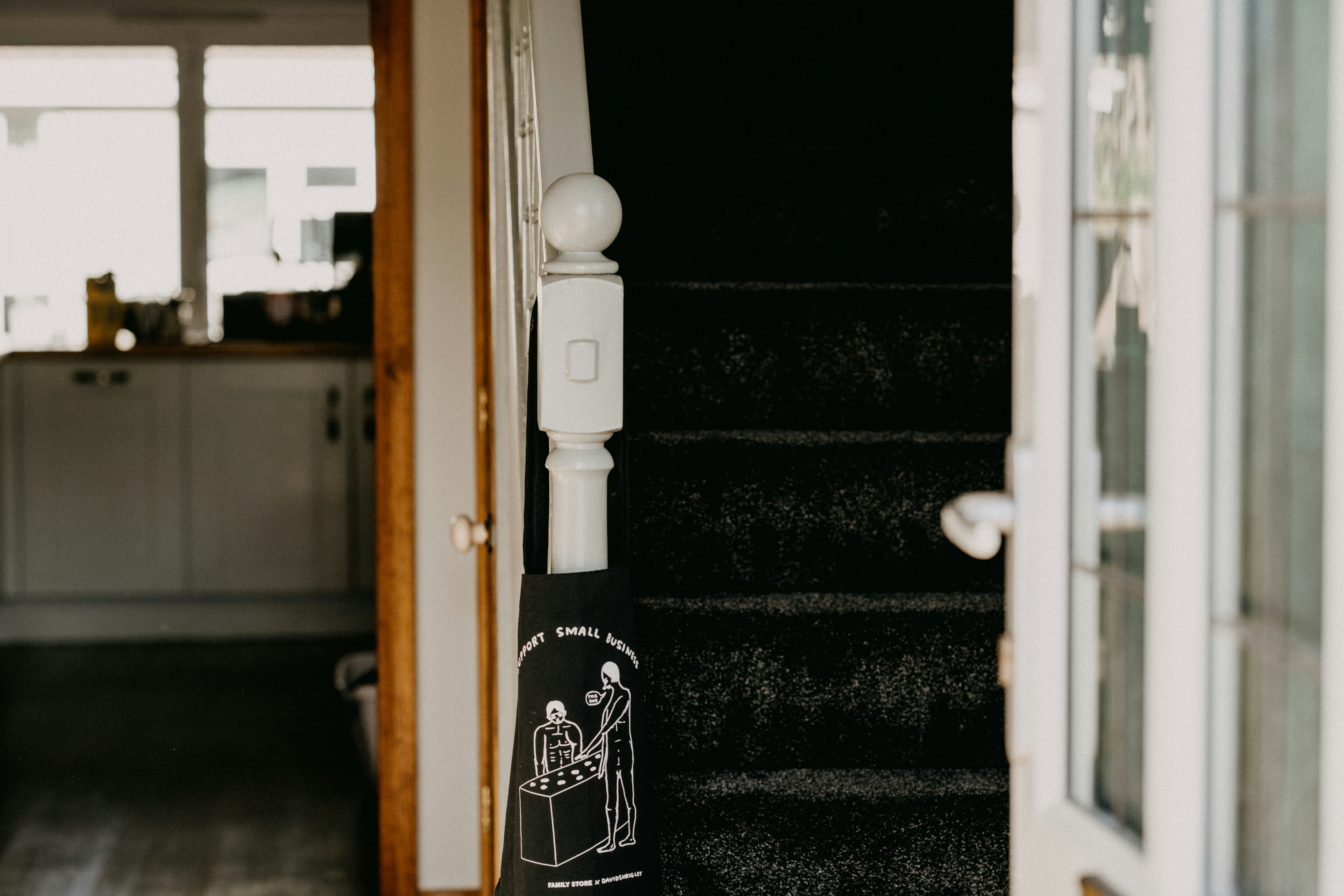 Poster on a Banister: Quiet Stairwell in Soft Light