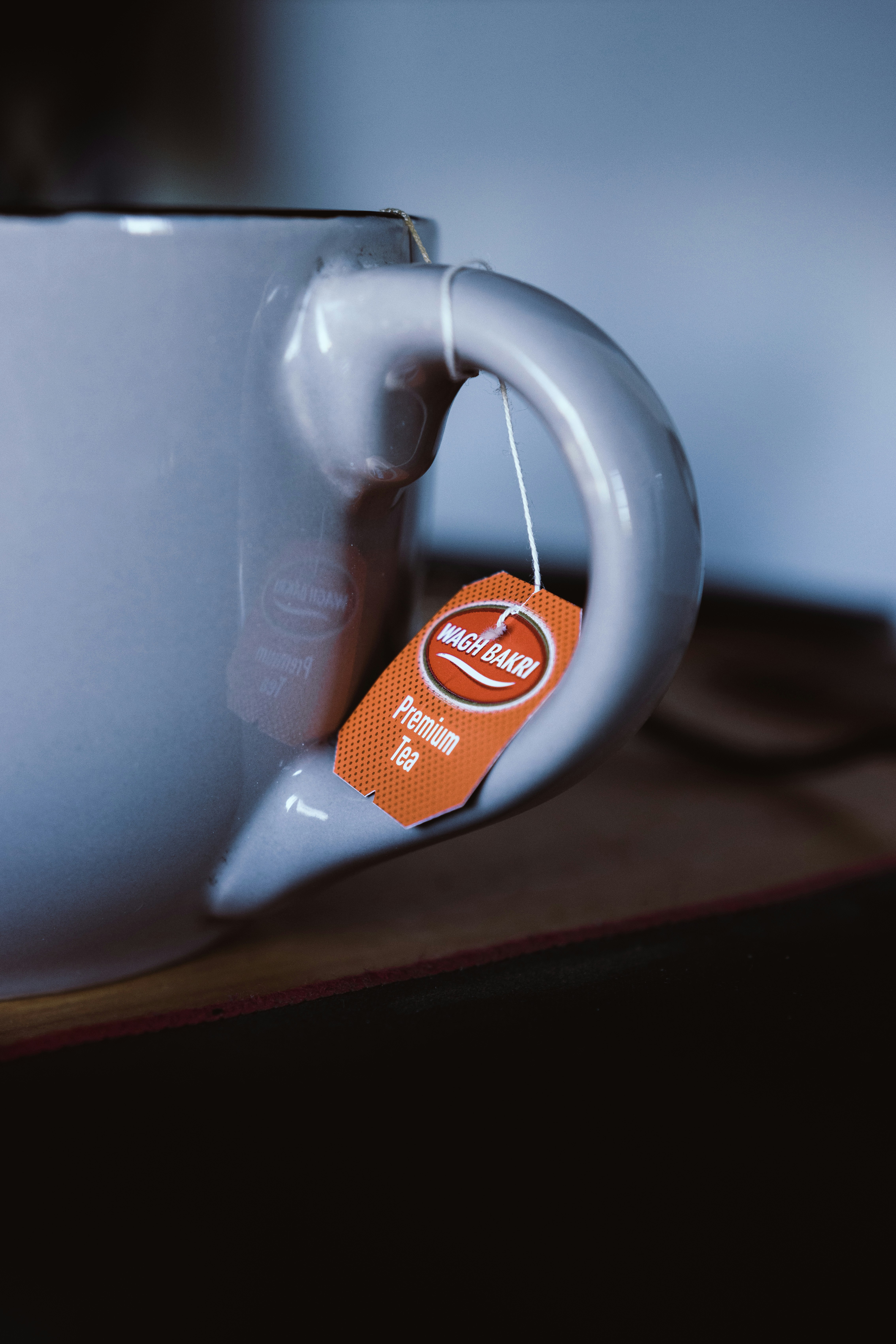 Orange Tea Tag on a Quiet Cup