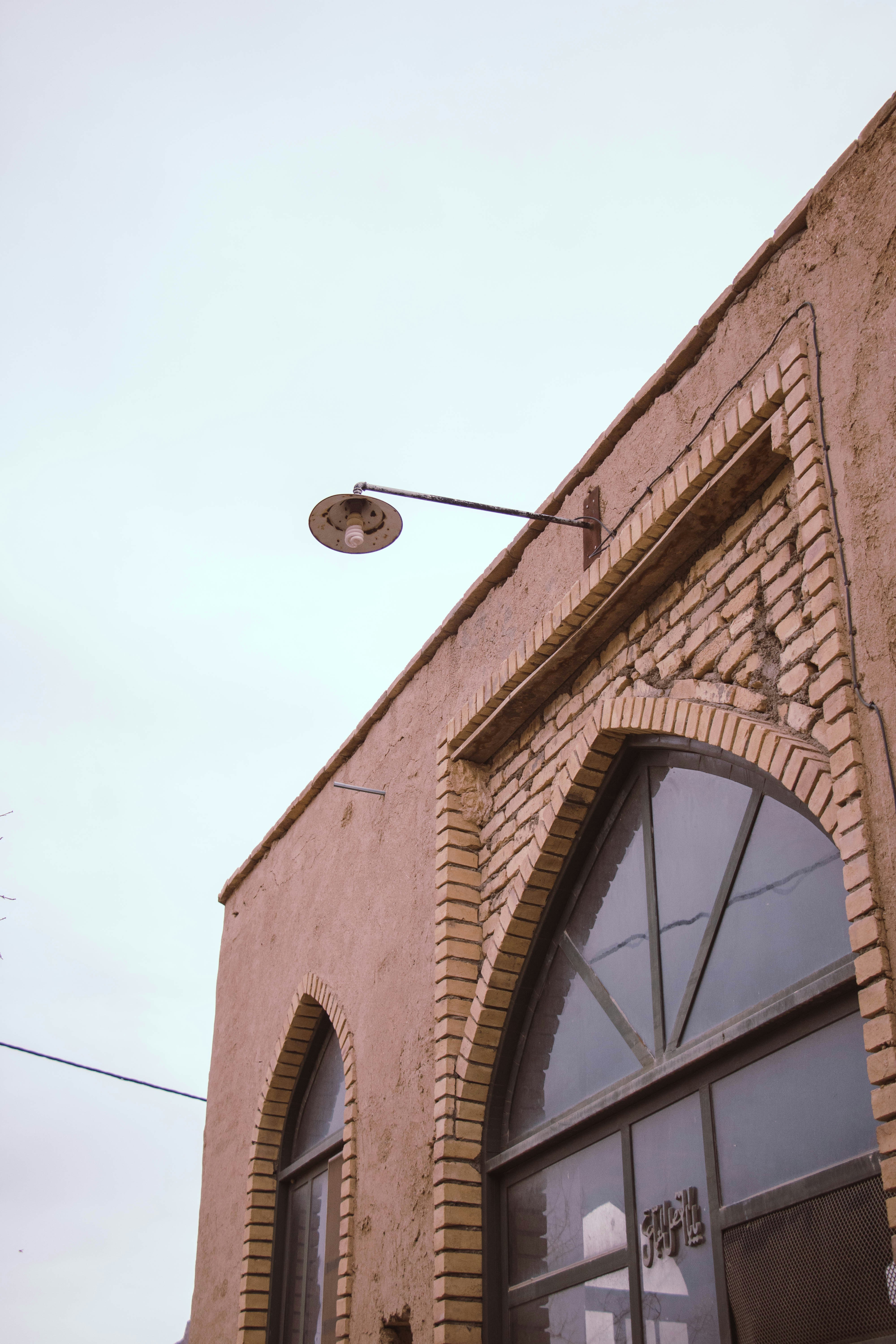 brown brick building with black and white street light