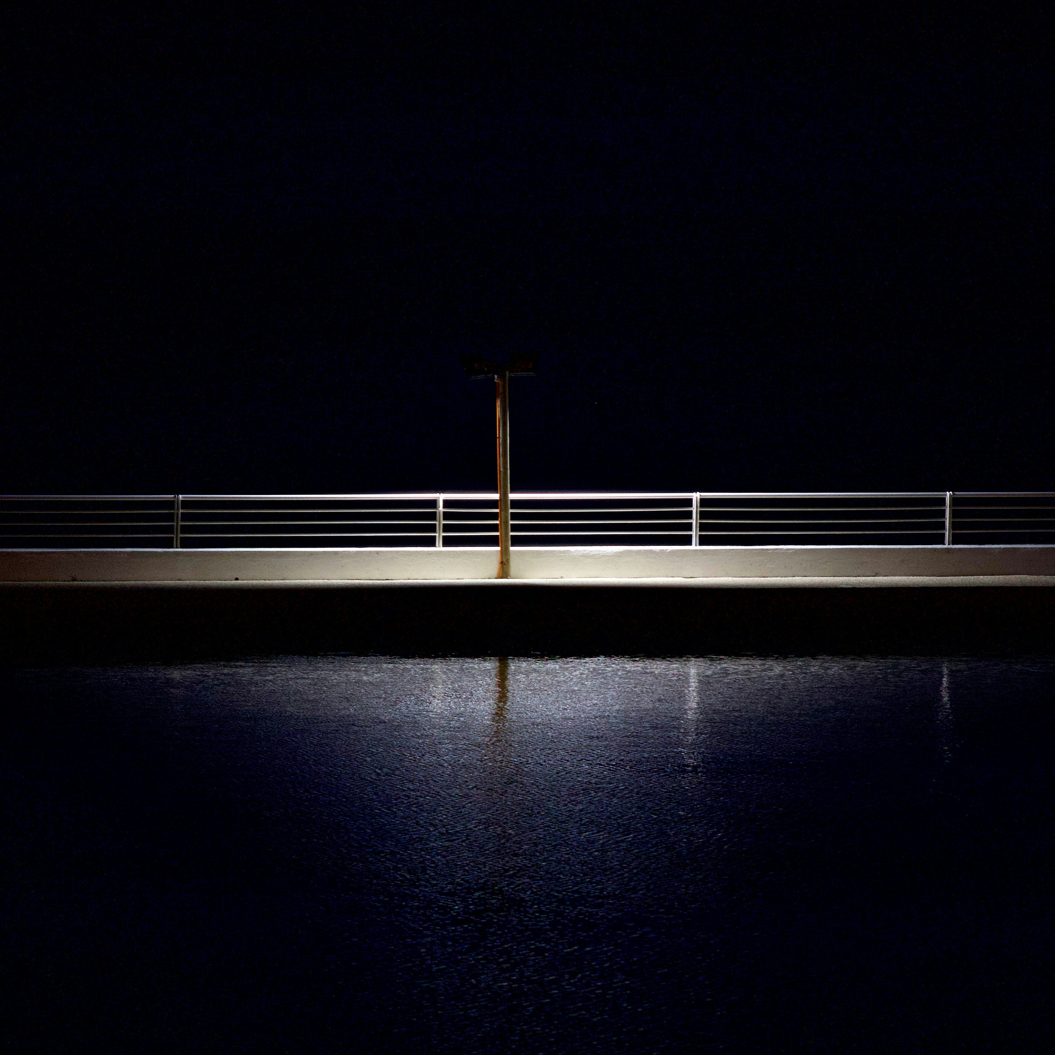 Midnight Pier Post: A Singular Beacon Over Velvet Waters