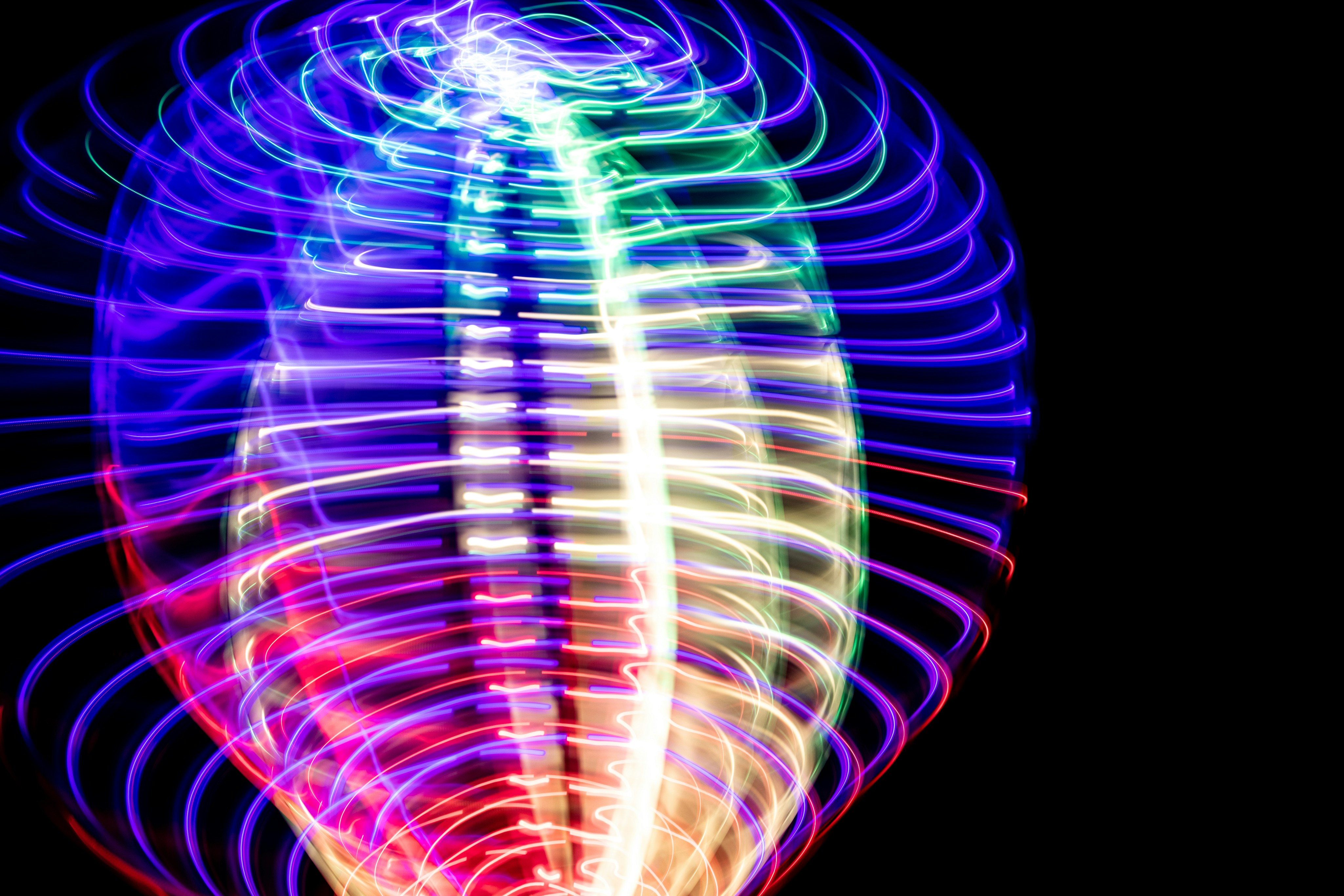 Spiraled Neon Core: A Rainbow-Light Bulb in Long-Exposure