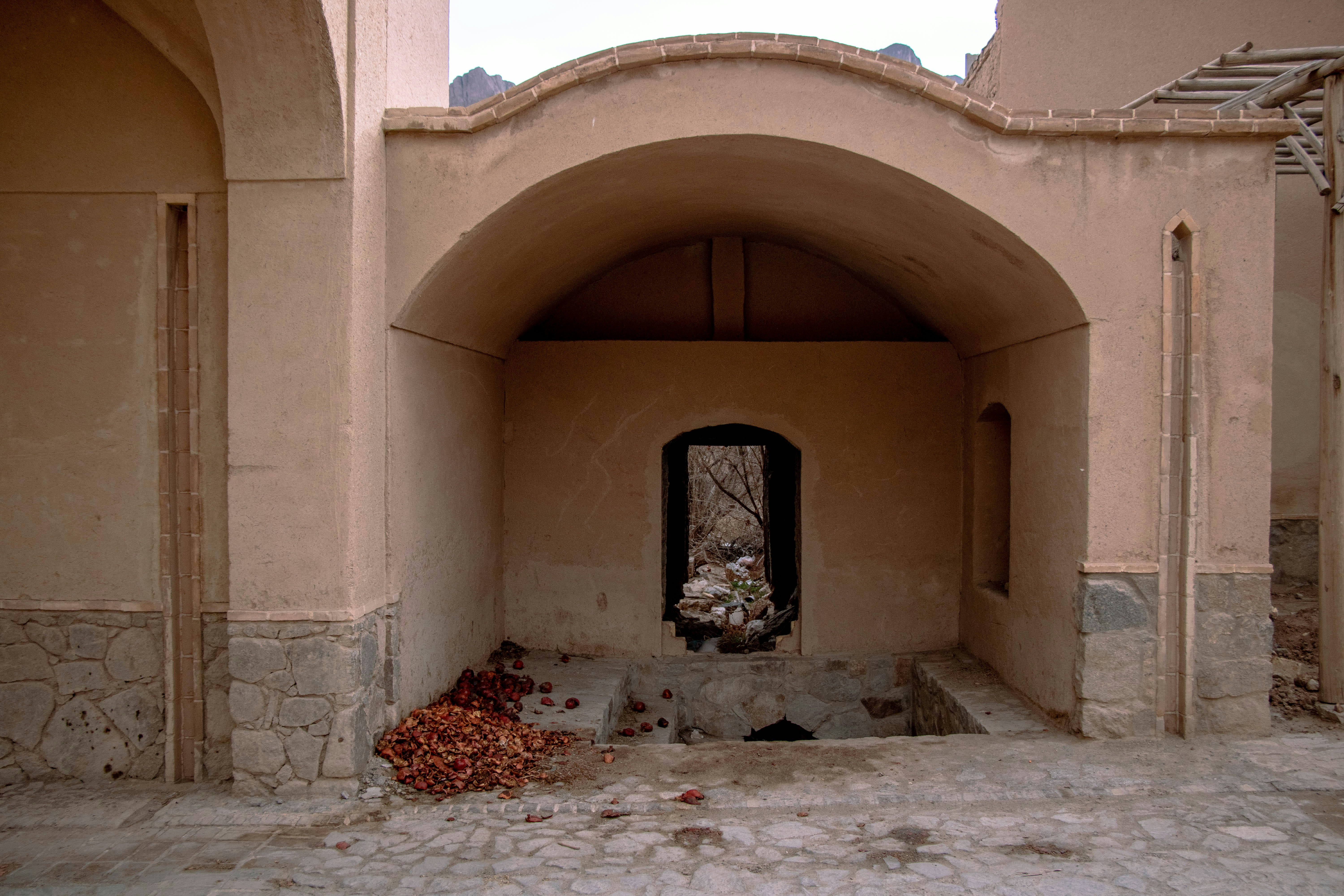 The Arch's Quiet Gaze: Sunlit Passage Through Ruined Walls