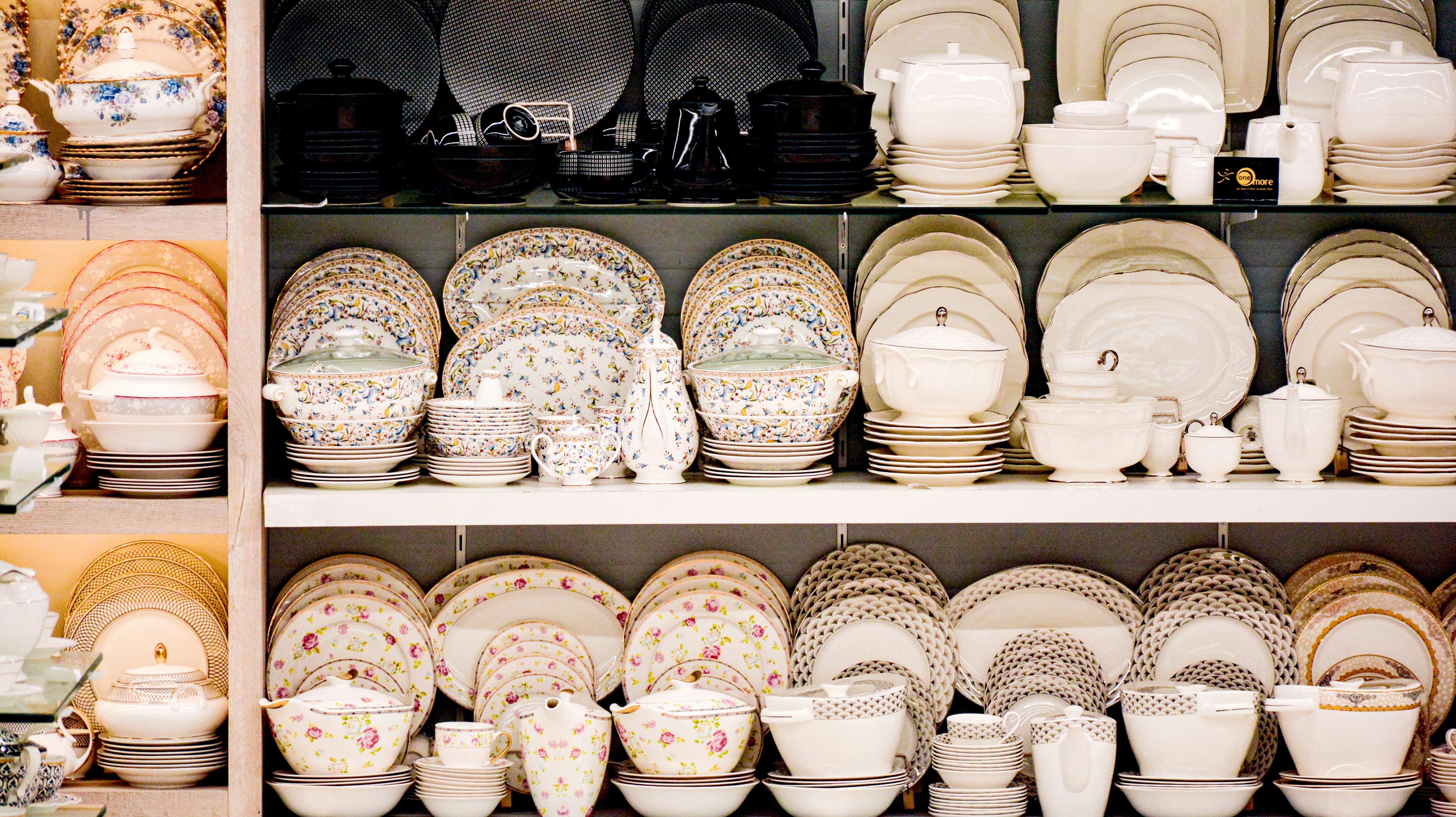 A curated collection of elegant tableware, showcasing various patterns and styles on neatly arranged shelves.