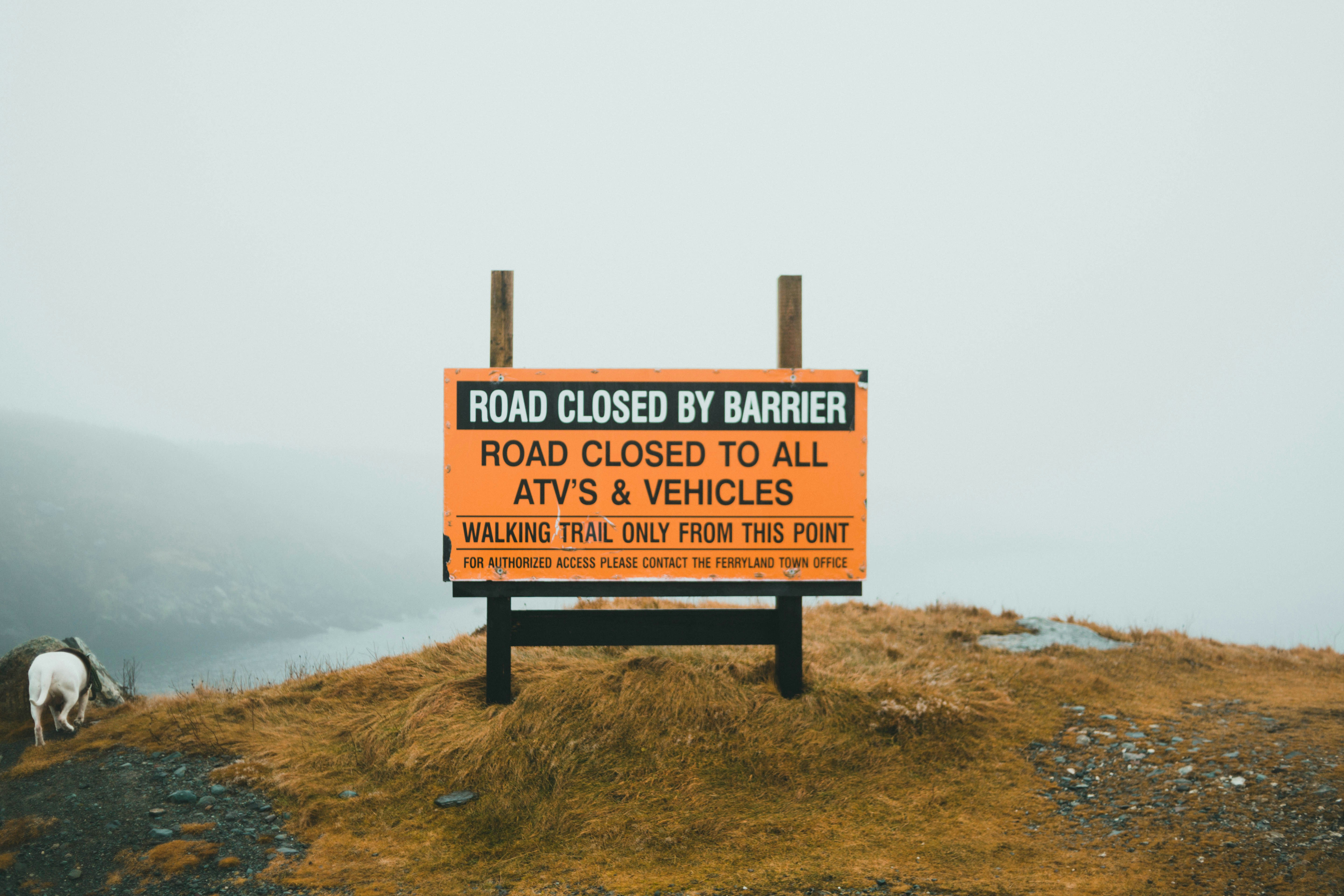 Orange Warning Sign on Windy Cliff Path