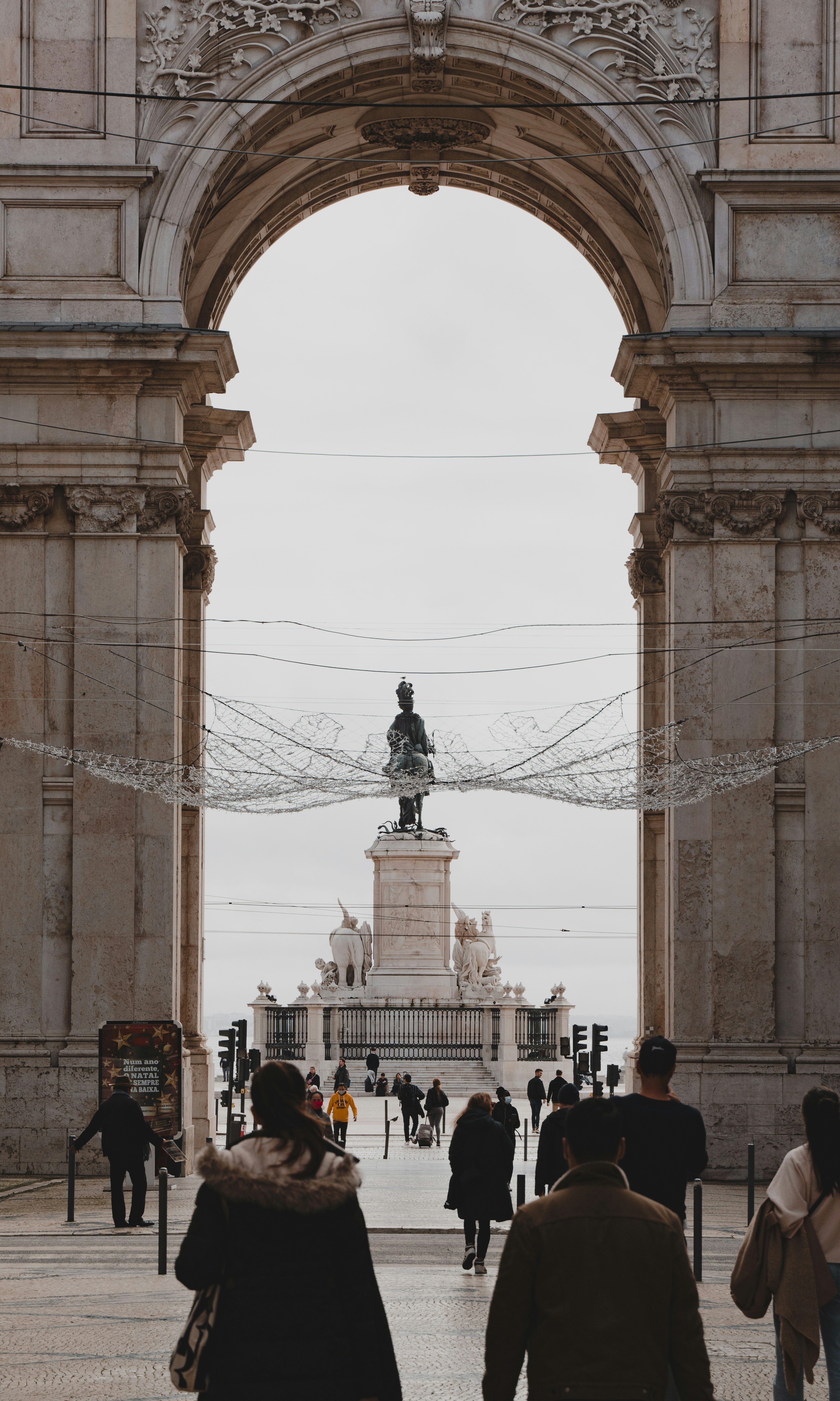 Gateway Archway Framing a Central Statue in Marble Plaza