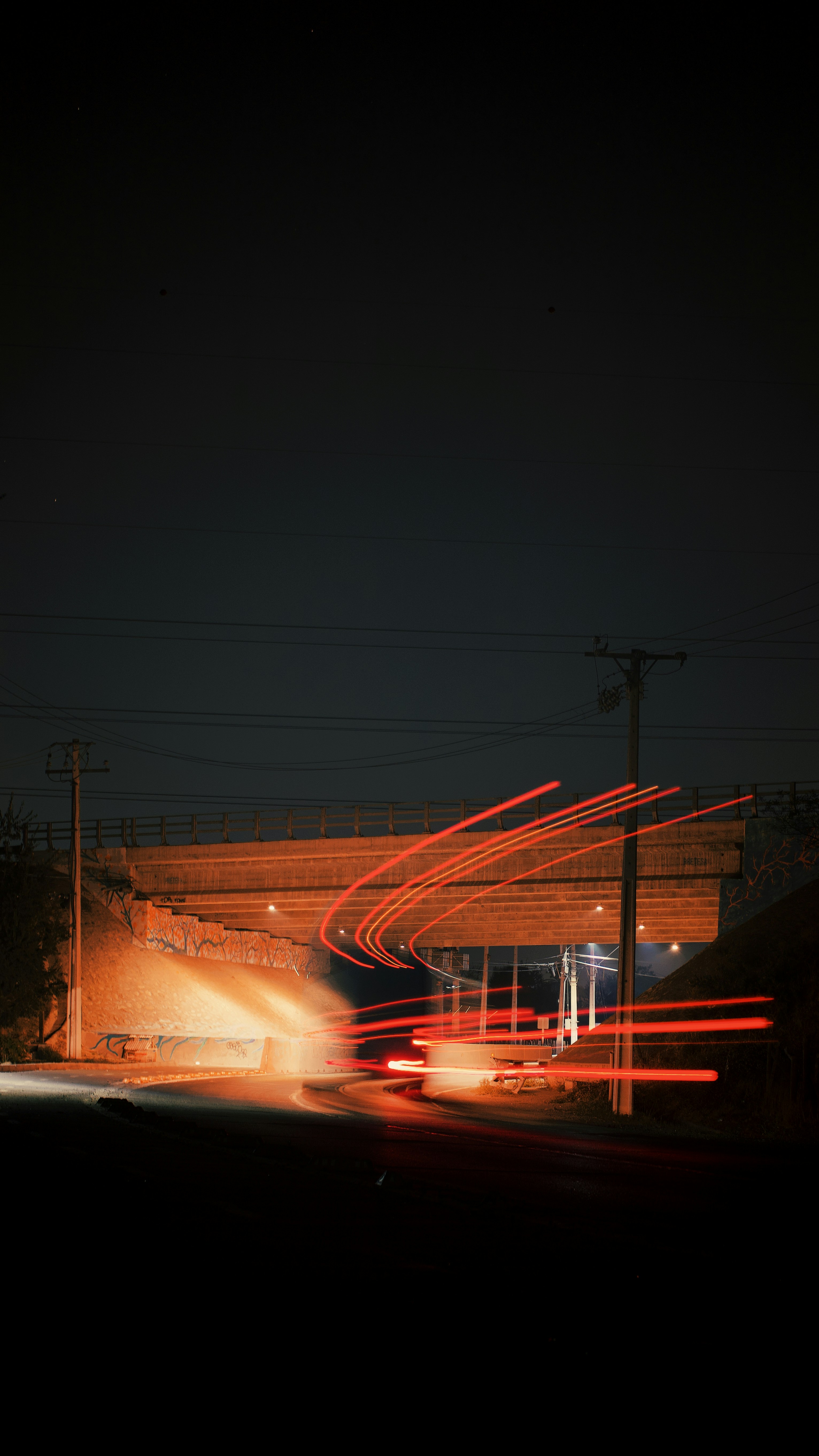 Red Veins of Night: Long-Exposure Run Under the Overpass