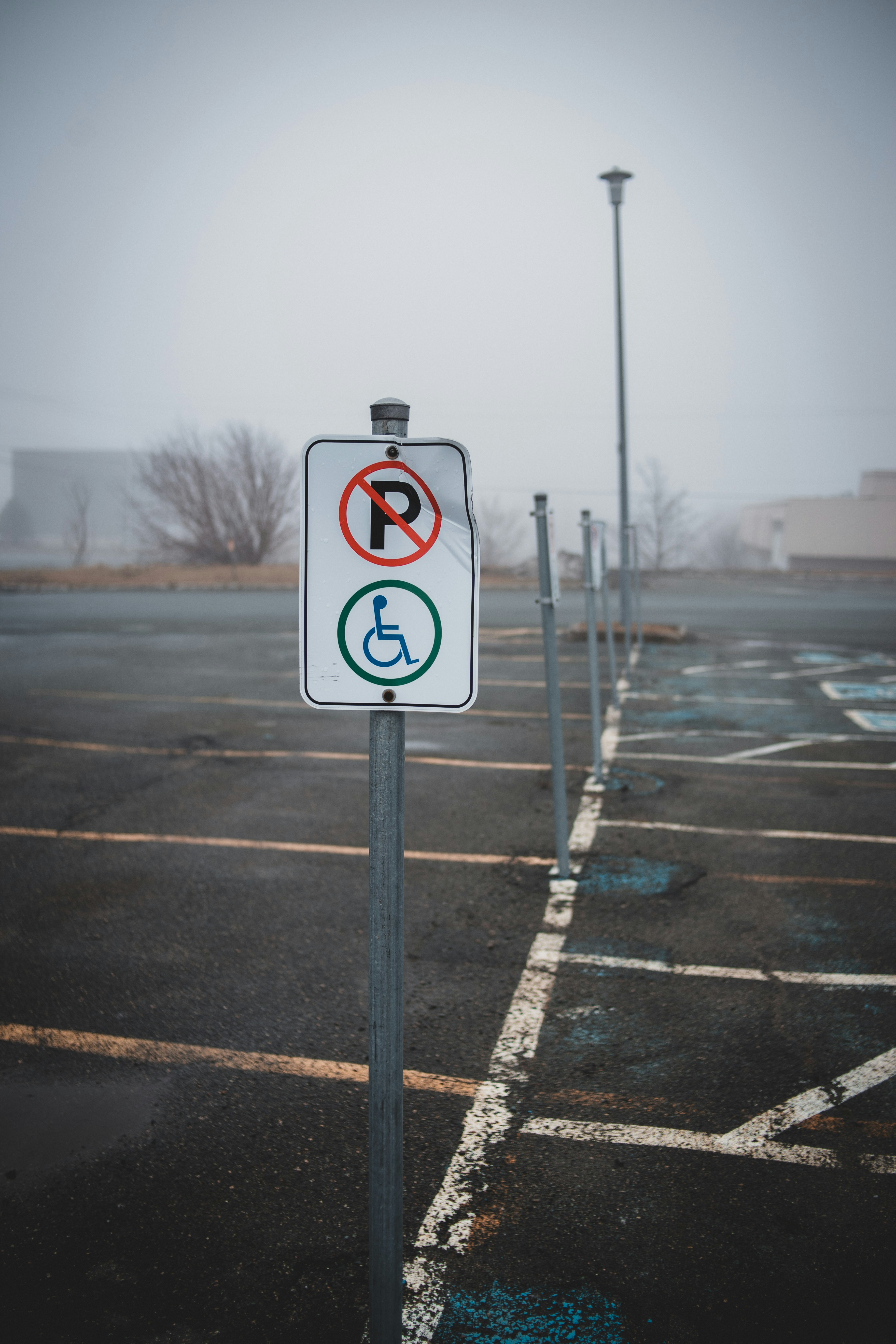 Disabled Parking Sign in Foggy Lot