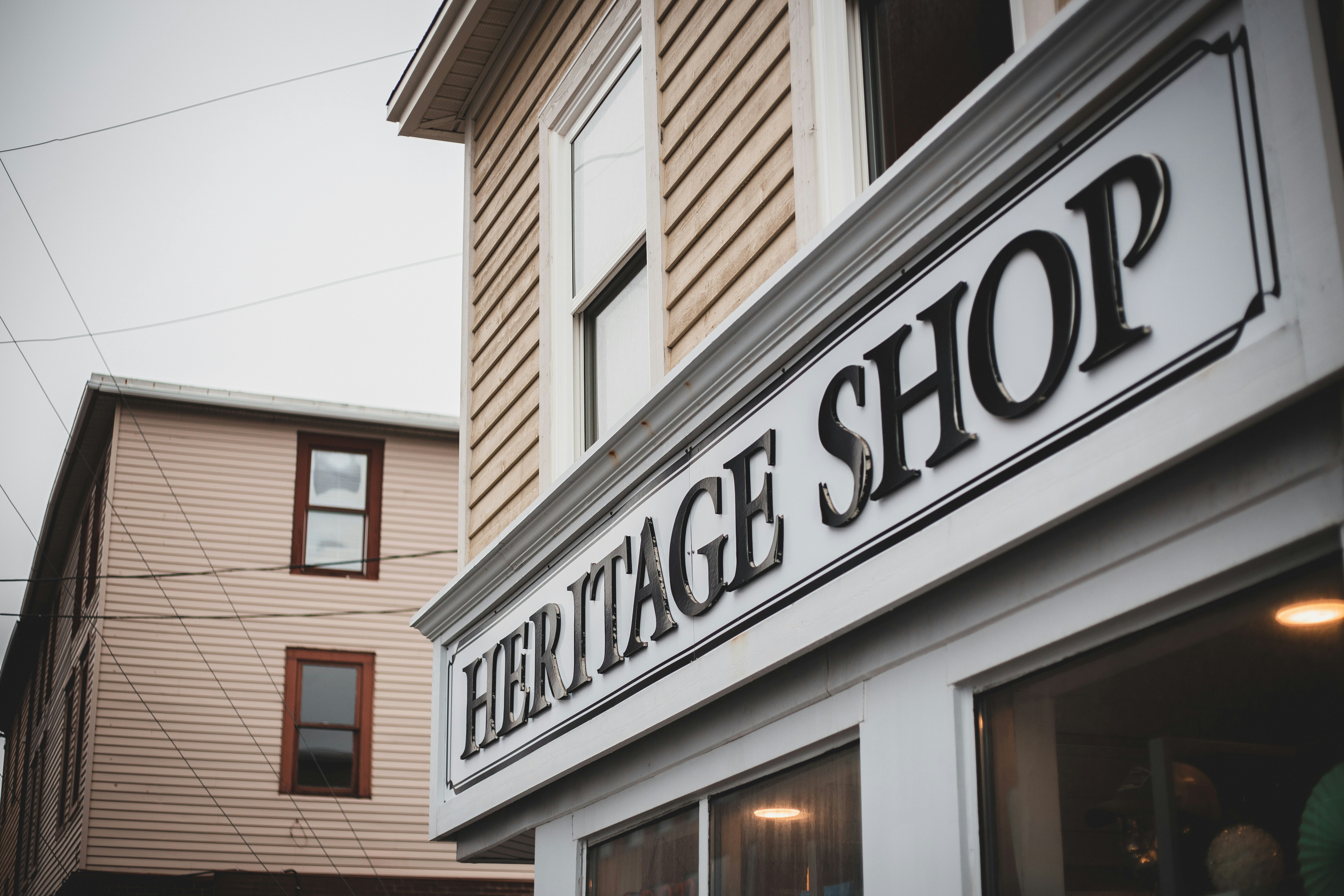 Brown brick building with white and black signage photo – Free Grey ...