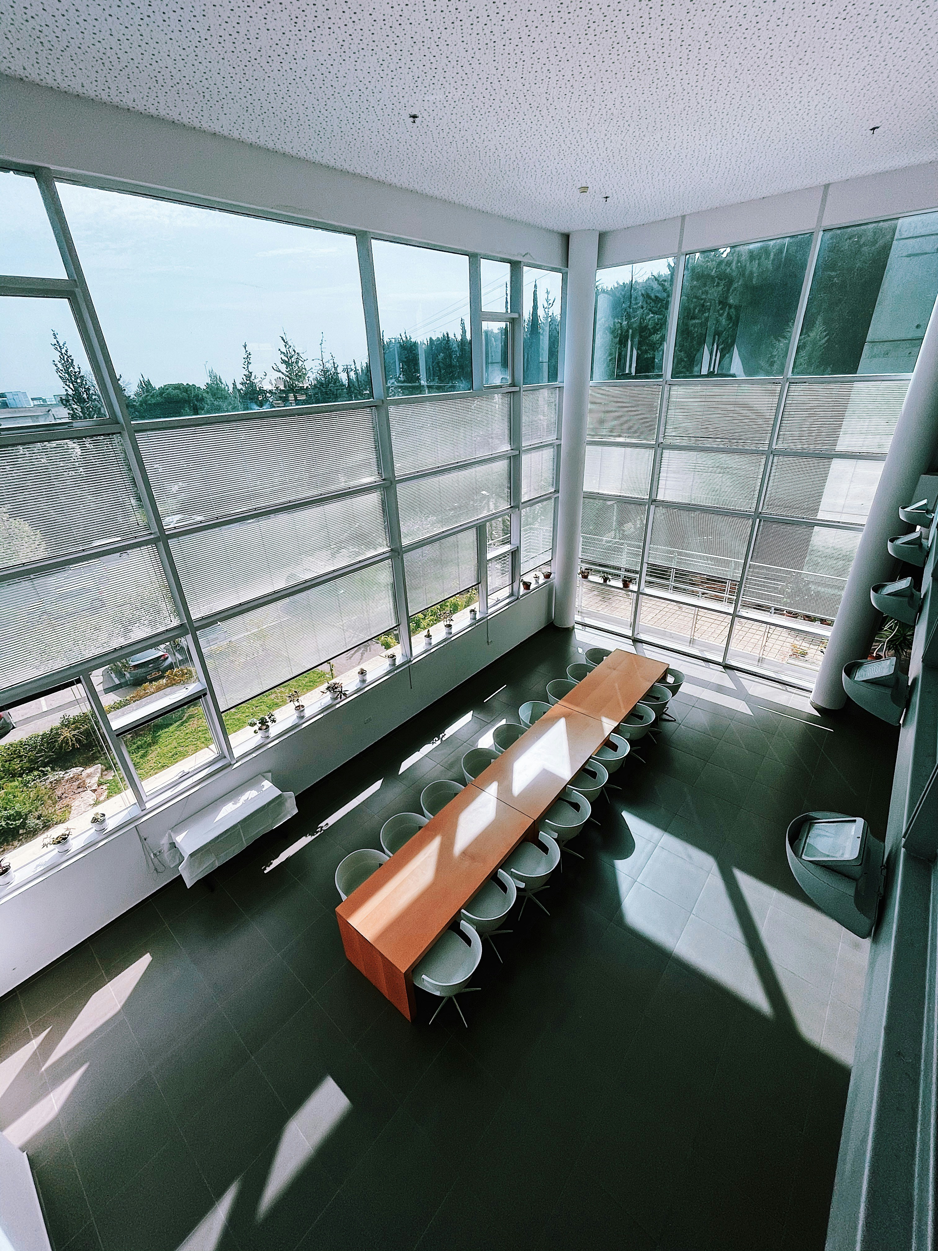 brown wooden bench near glass window