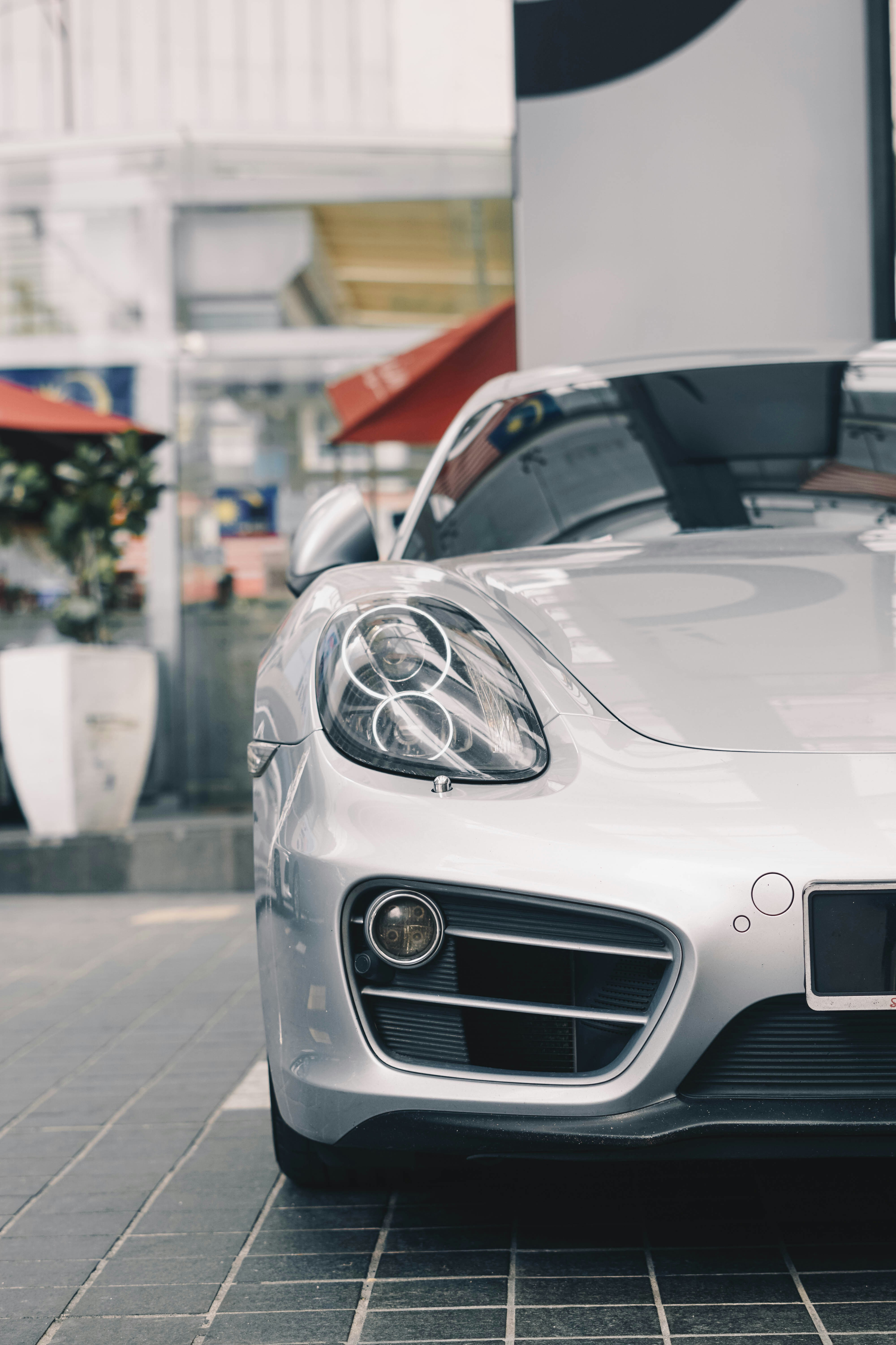 Chrome Contour at Street Level: Front-Facing Portrait of a Silver Sports Car