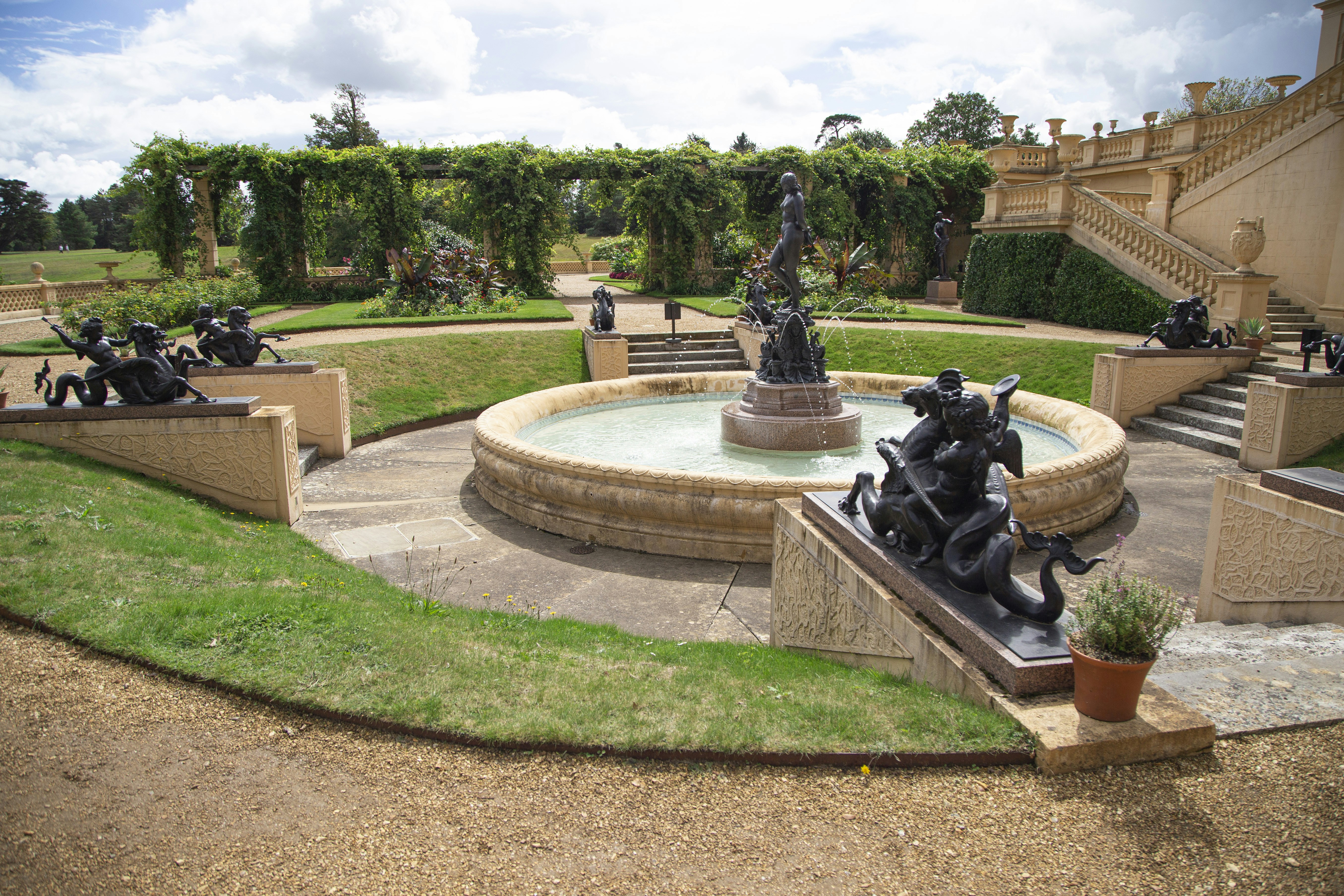 Stone Statues at a Tiered Fountain Garden