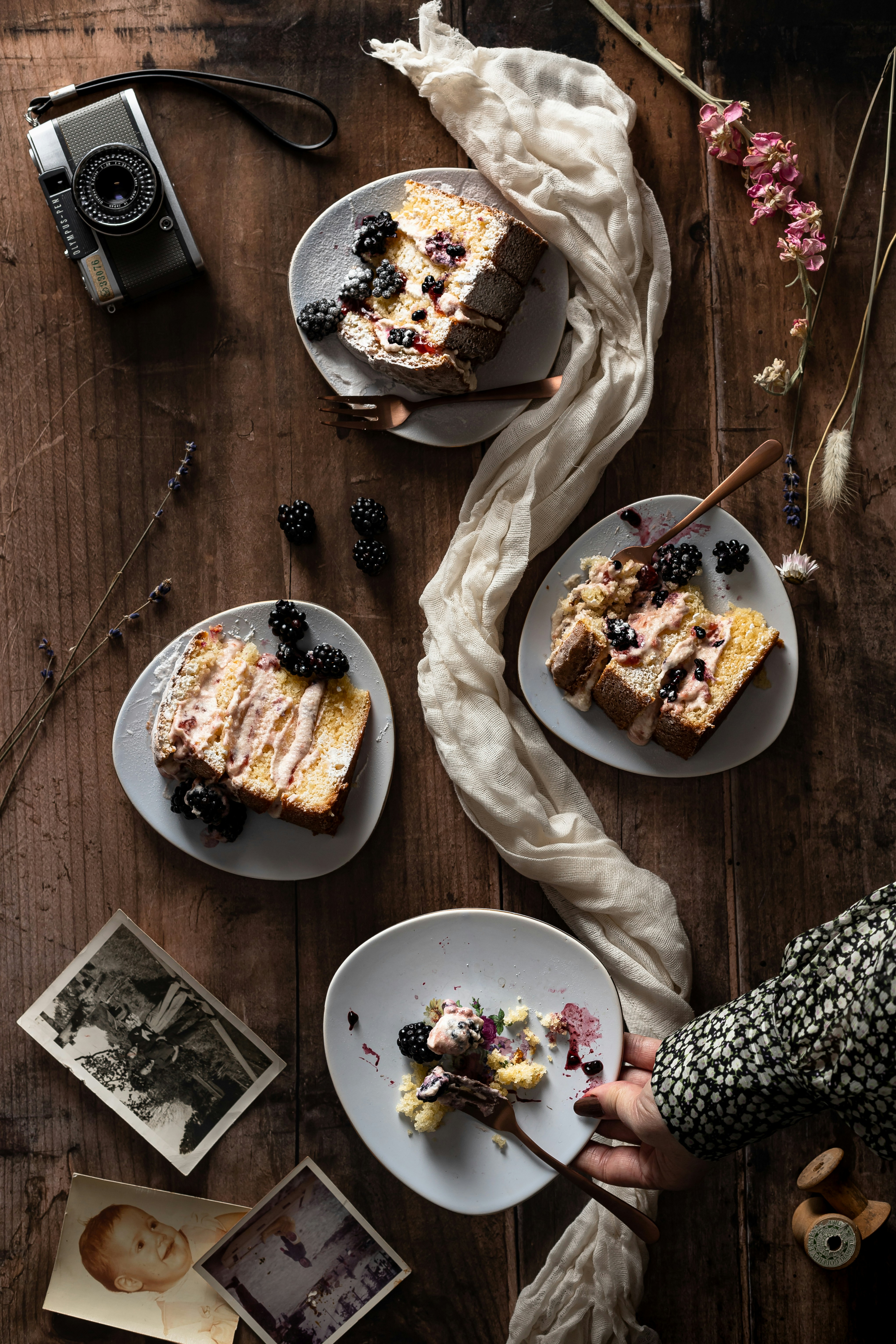 Berry-Topped Cake Triad on a Weathered Wooden Table