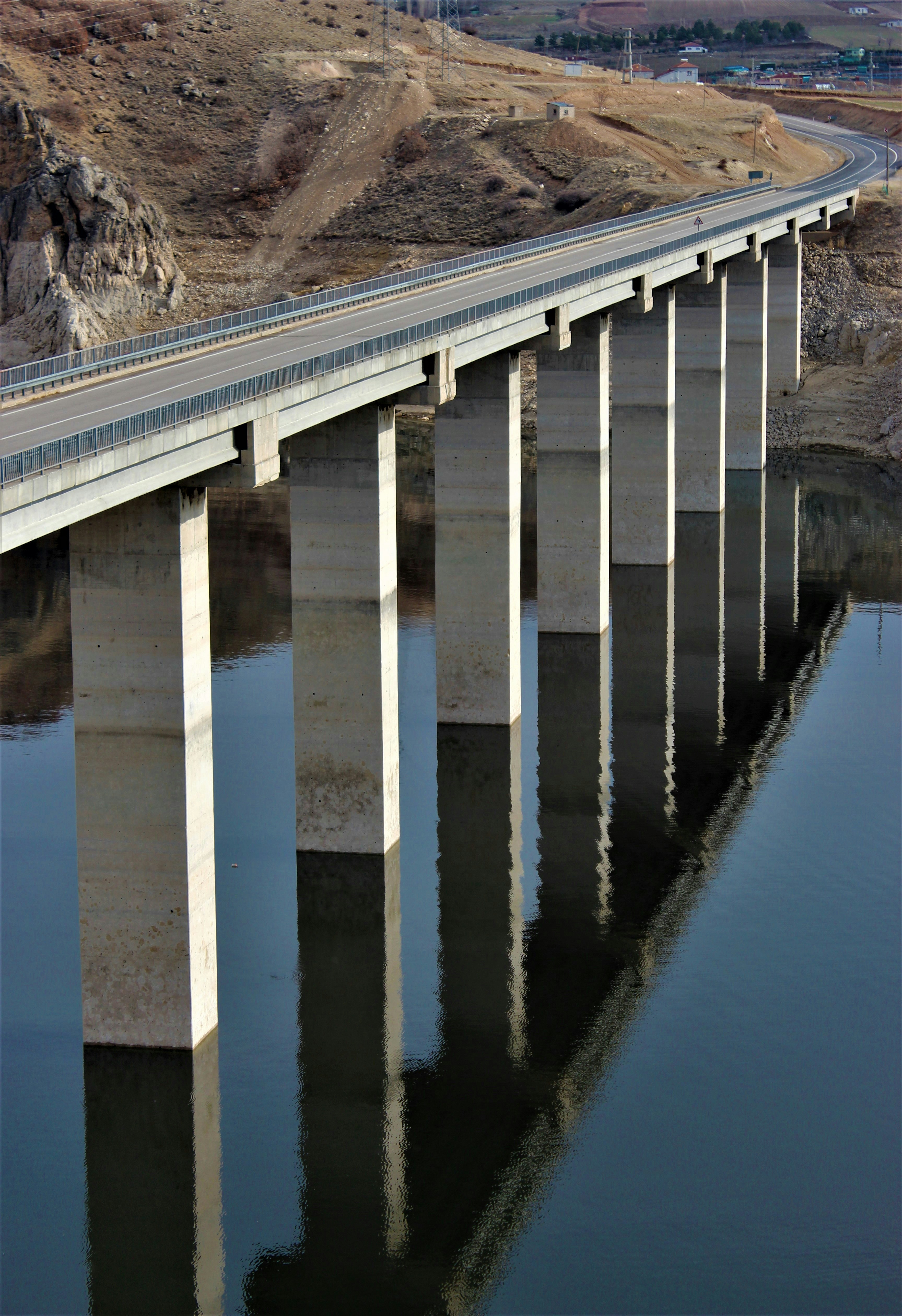 brown wooden bridge over blue water