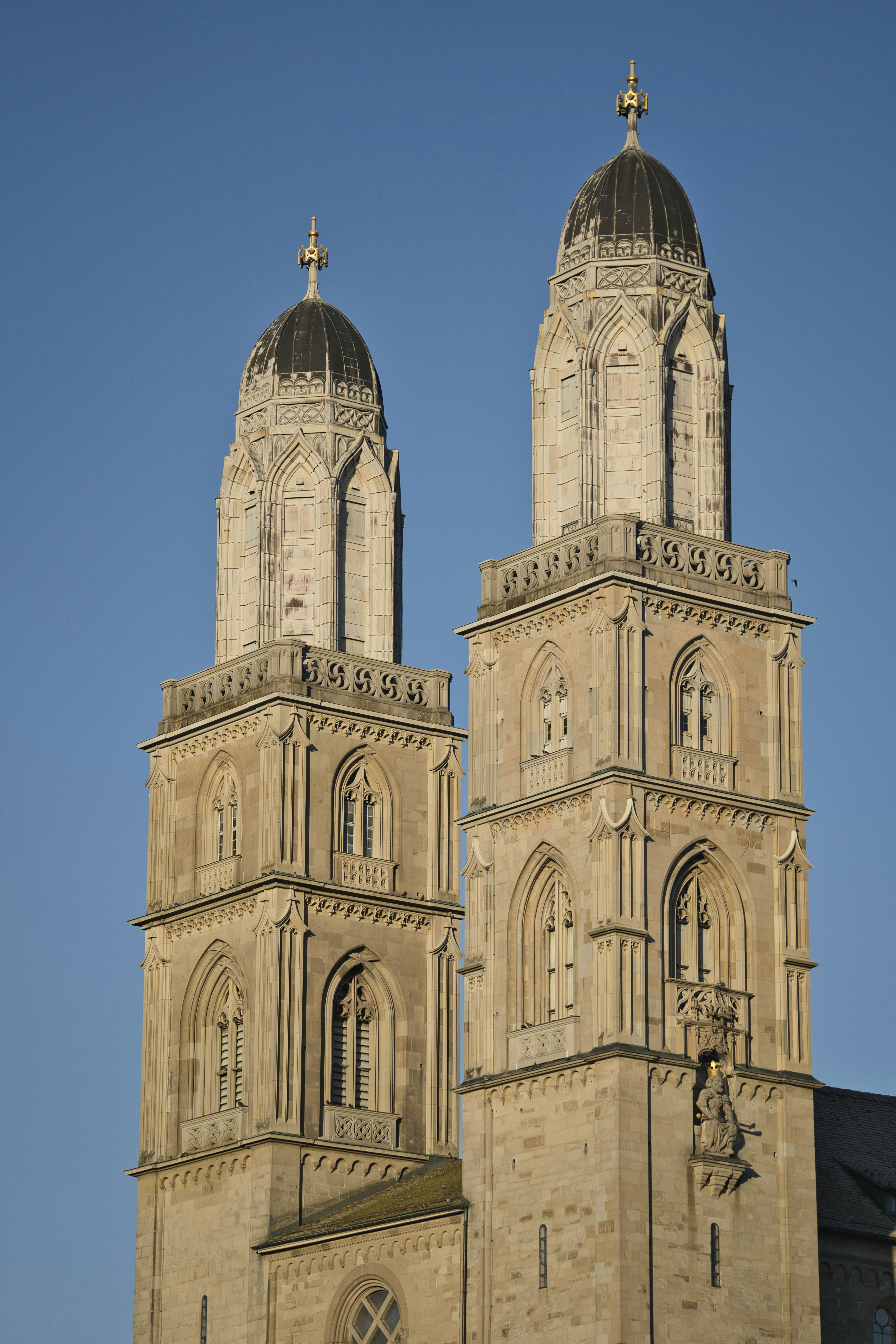 Architectural marvel featuring twin towers adorned with intricate details against a clear blue sky.