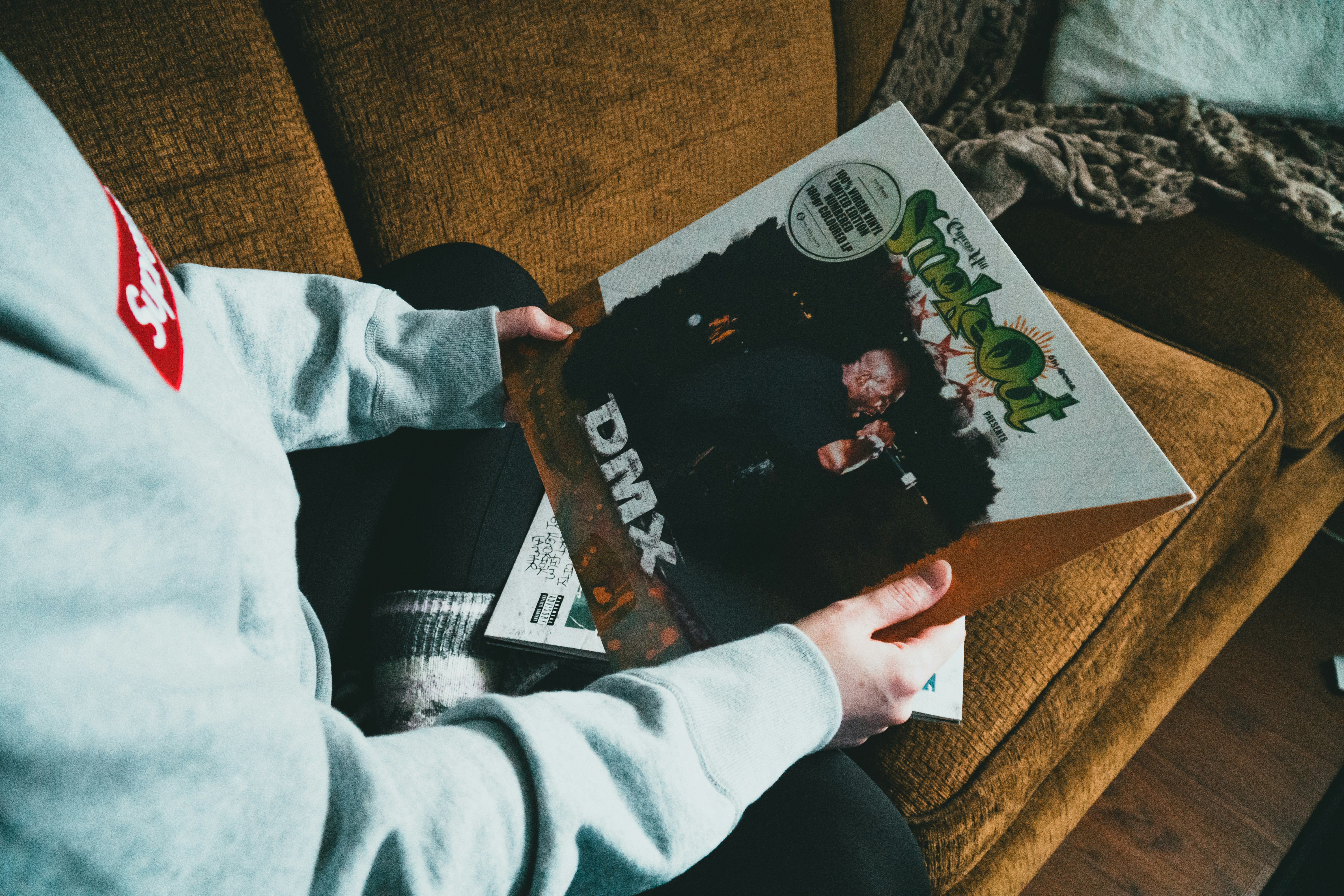 Couchside Graphic: A Hoodie-Clad Reader Grips a Bold Magazine Box