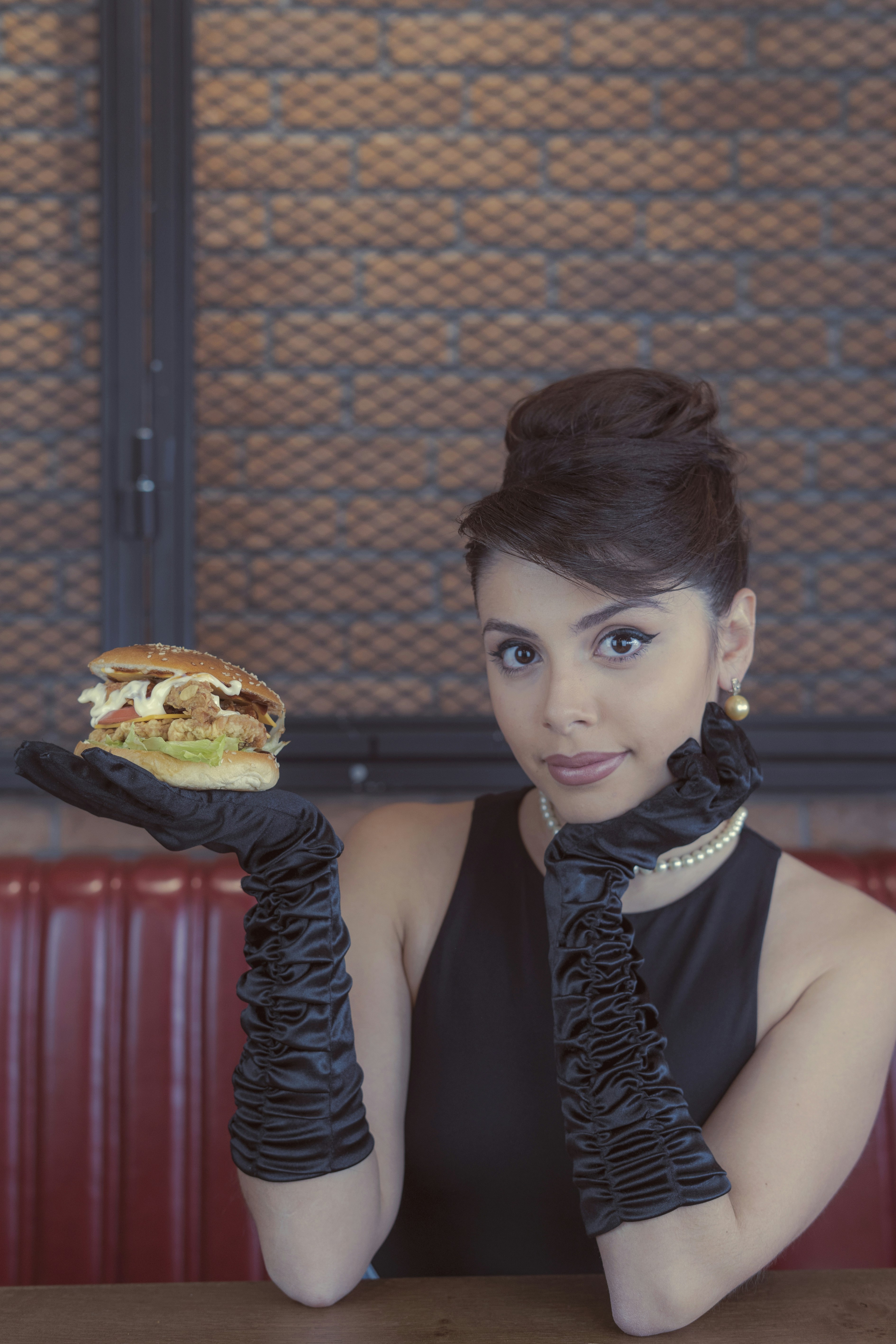 Mid-Century Glamour: A Burger-Presenting Portrait in Black Satin Gloves