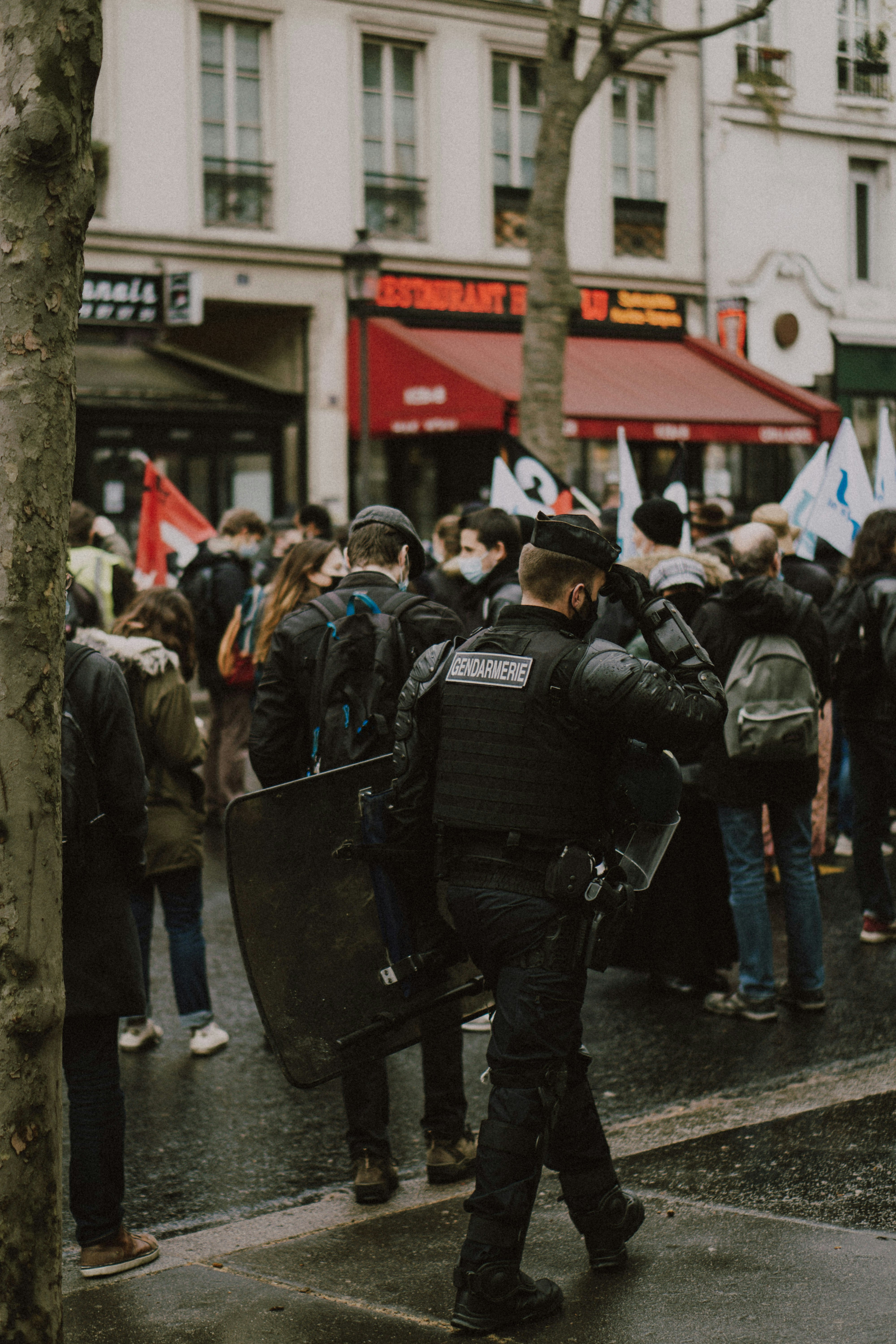 man in black jacket carrying black backpack walking on street during daytimeEmile