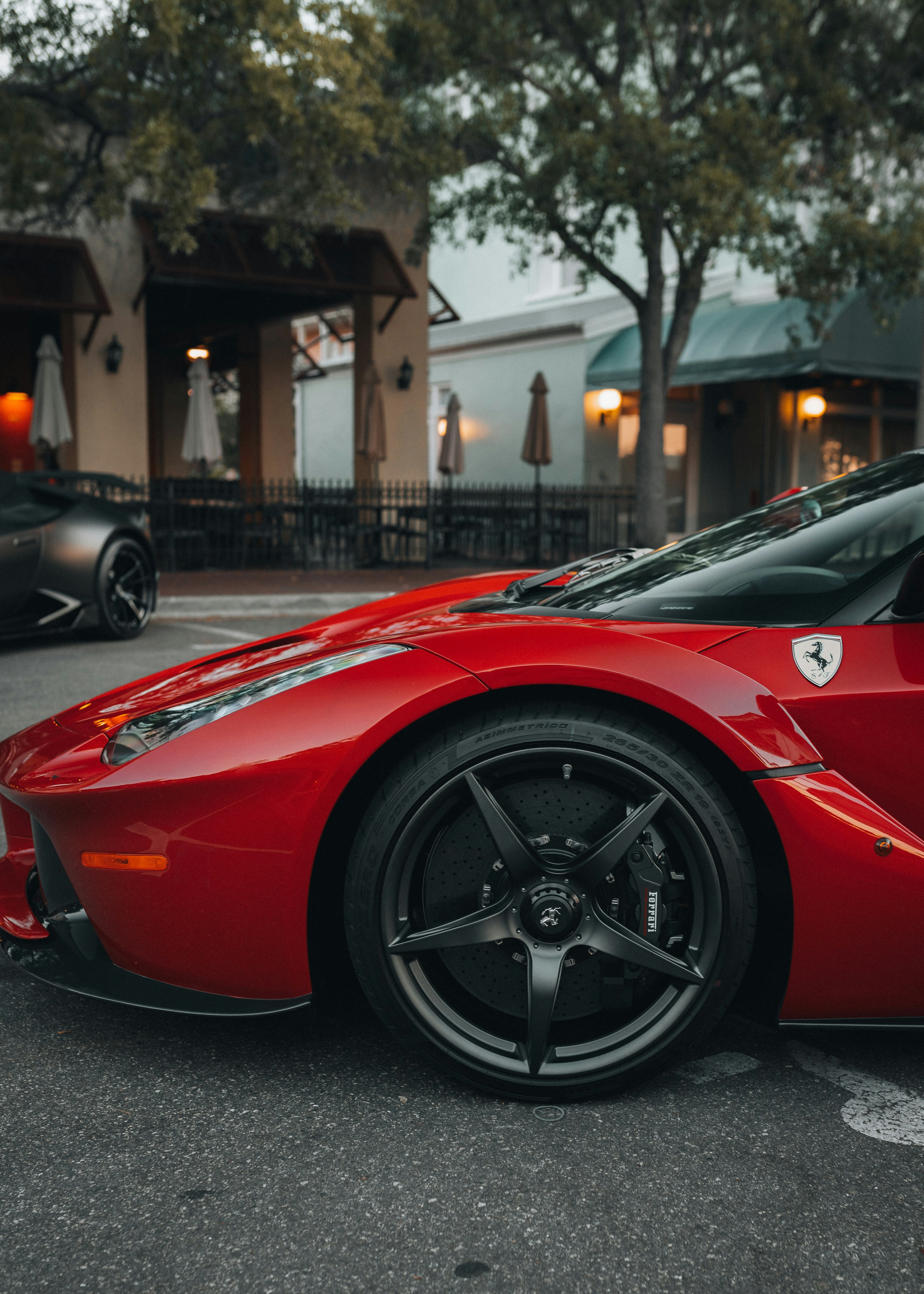 Crimson Precision on Pavement: Ferrari's Front Wheel in Focus