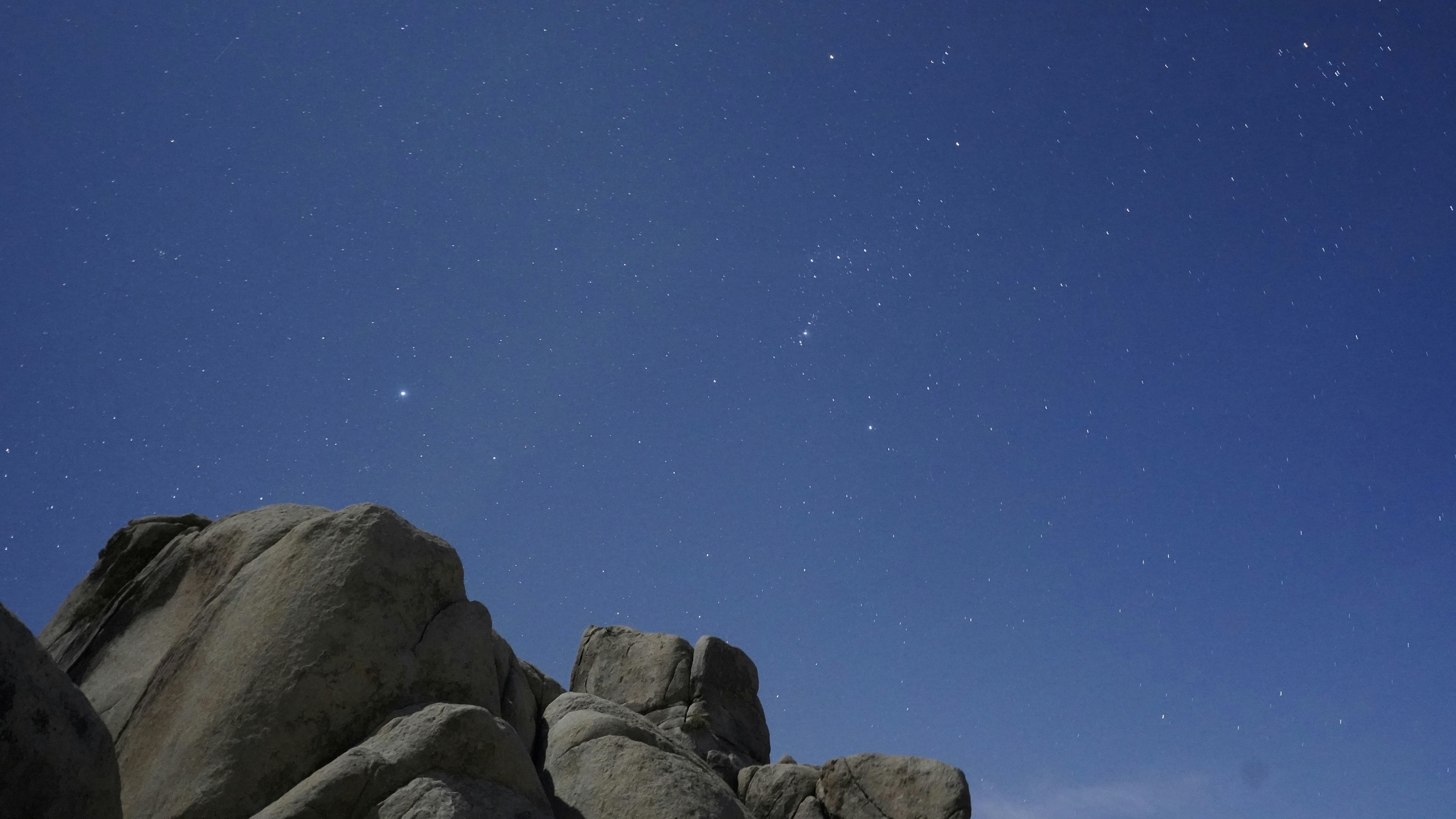 Granite Sentinel Under a Star-Filled Night