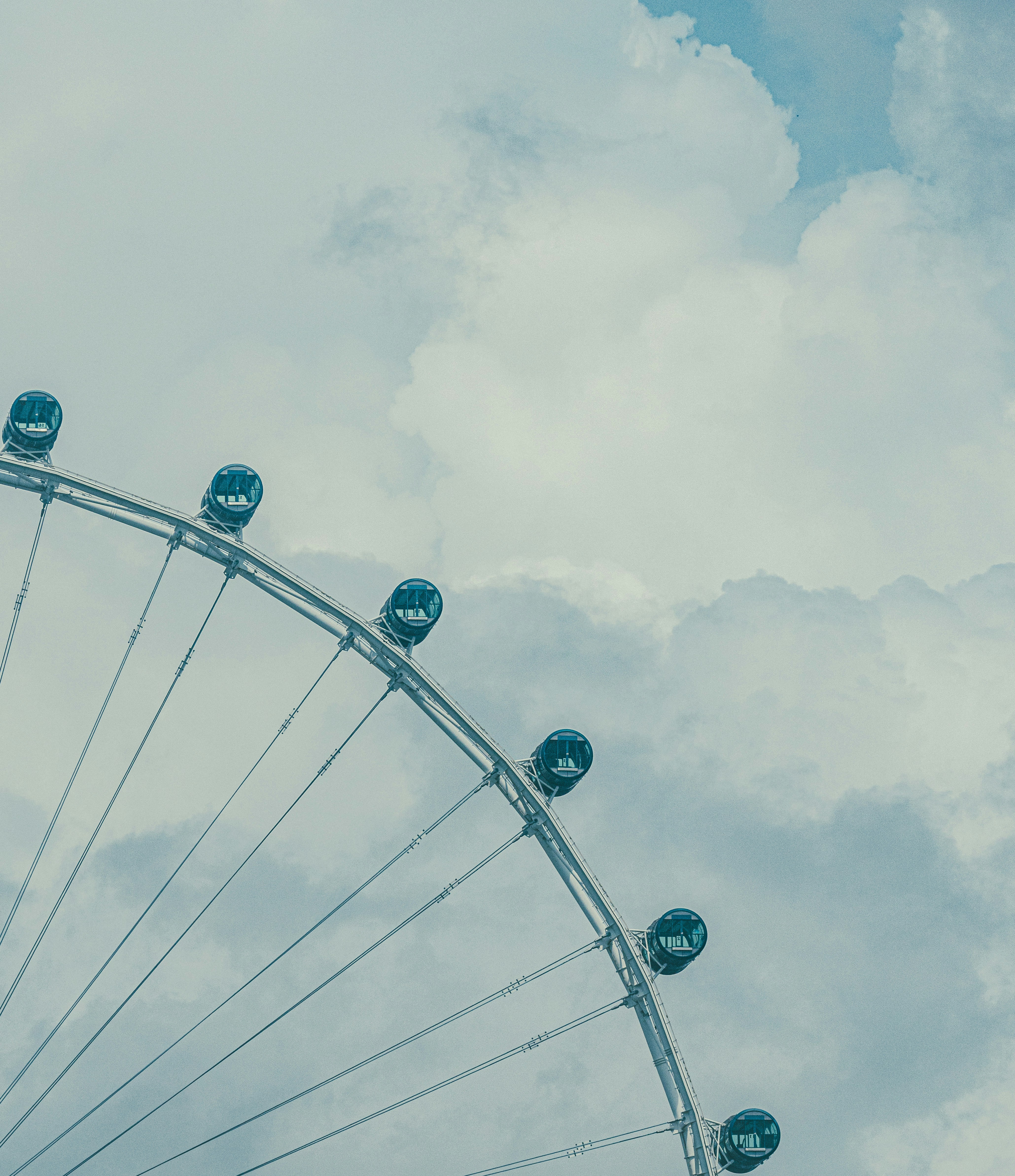 Whispers of the Sky: A Ferris Wheel's Dance with Clouds
