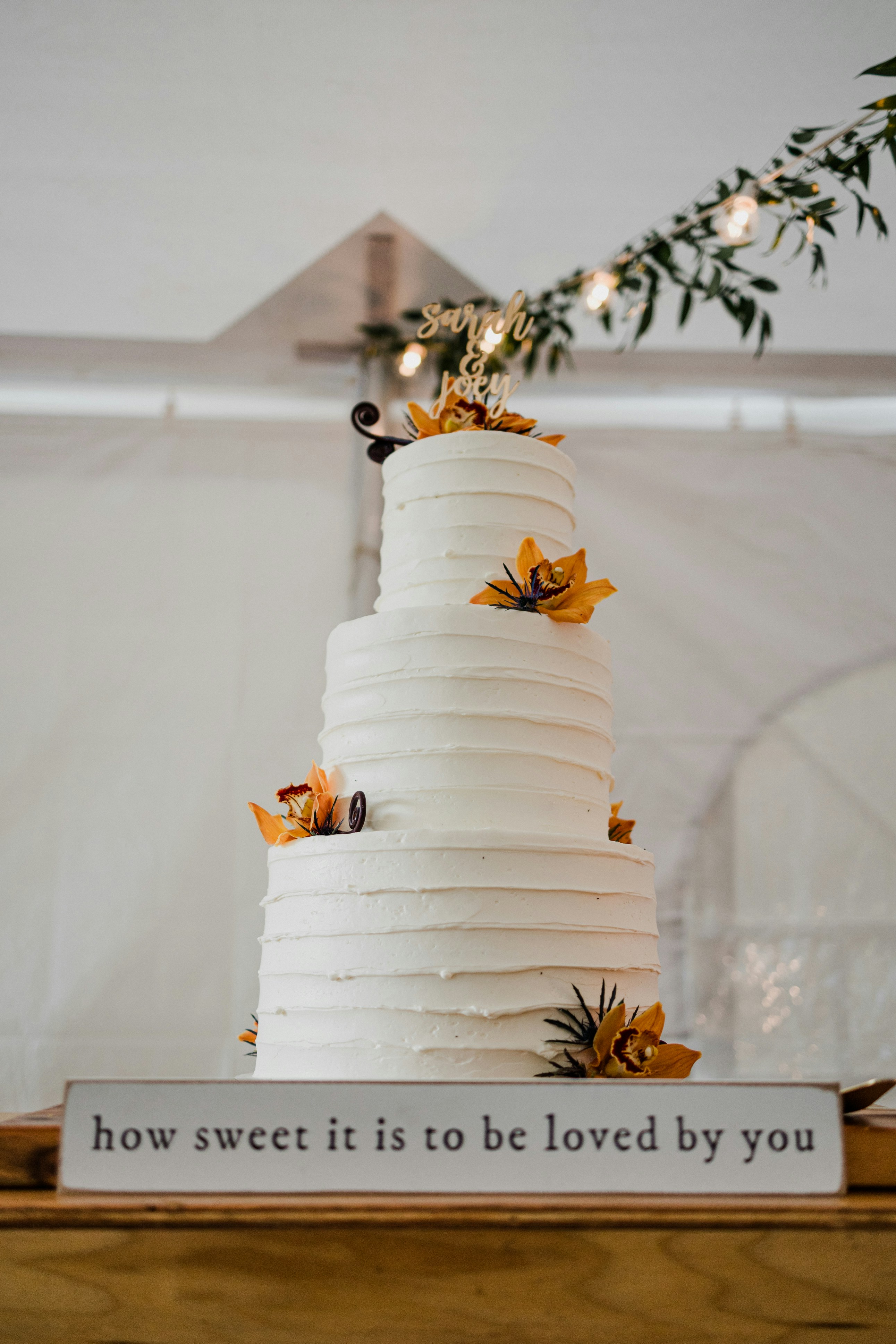 White 4 tier cake with yellow flowers on top photo – Free Wedding cake ...