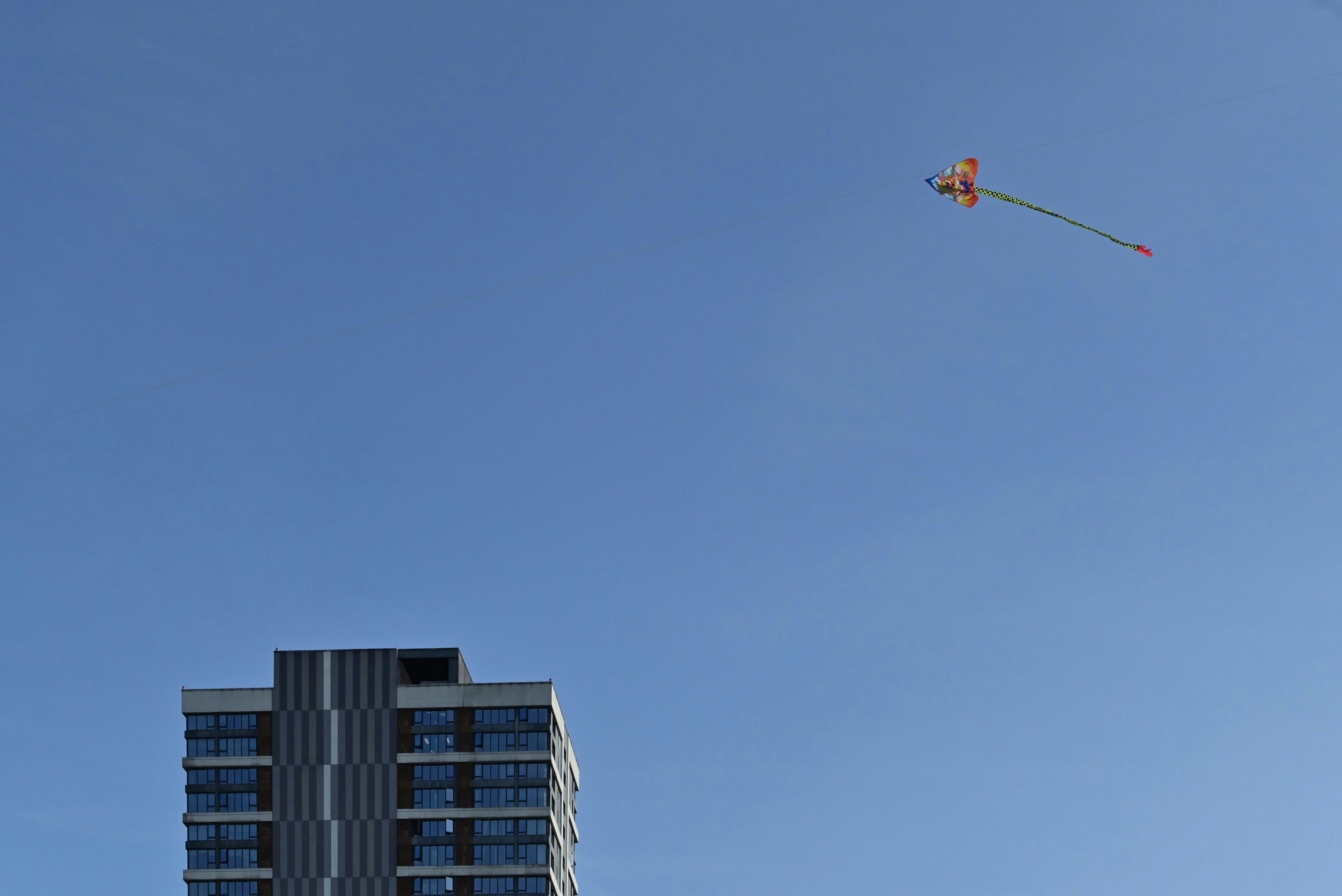 Kite Soaring Above a Modern Skyline