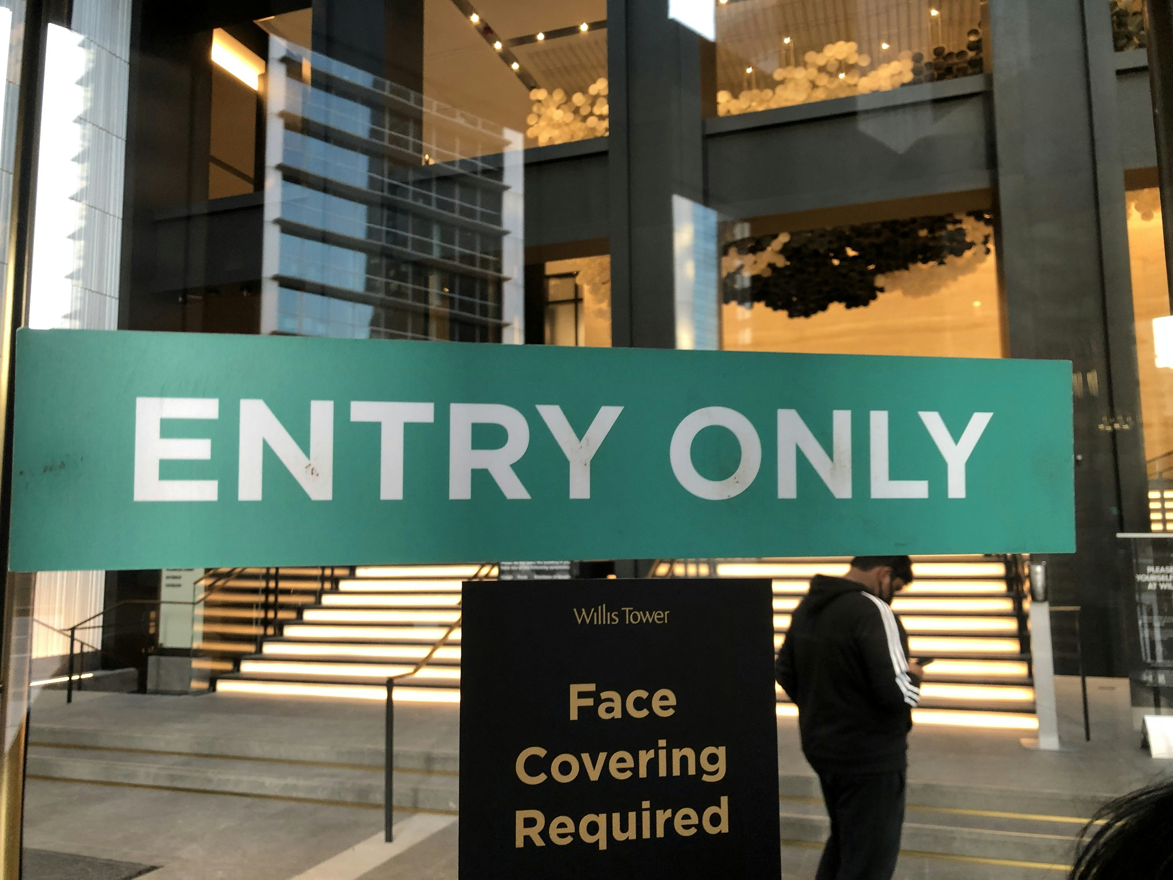 man in black jacket standing near the building