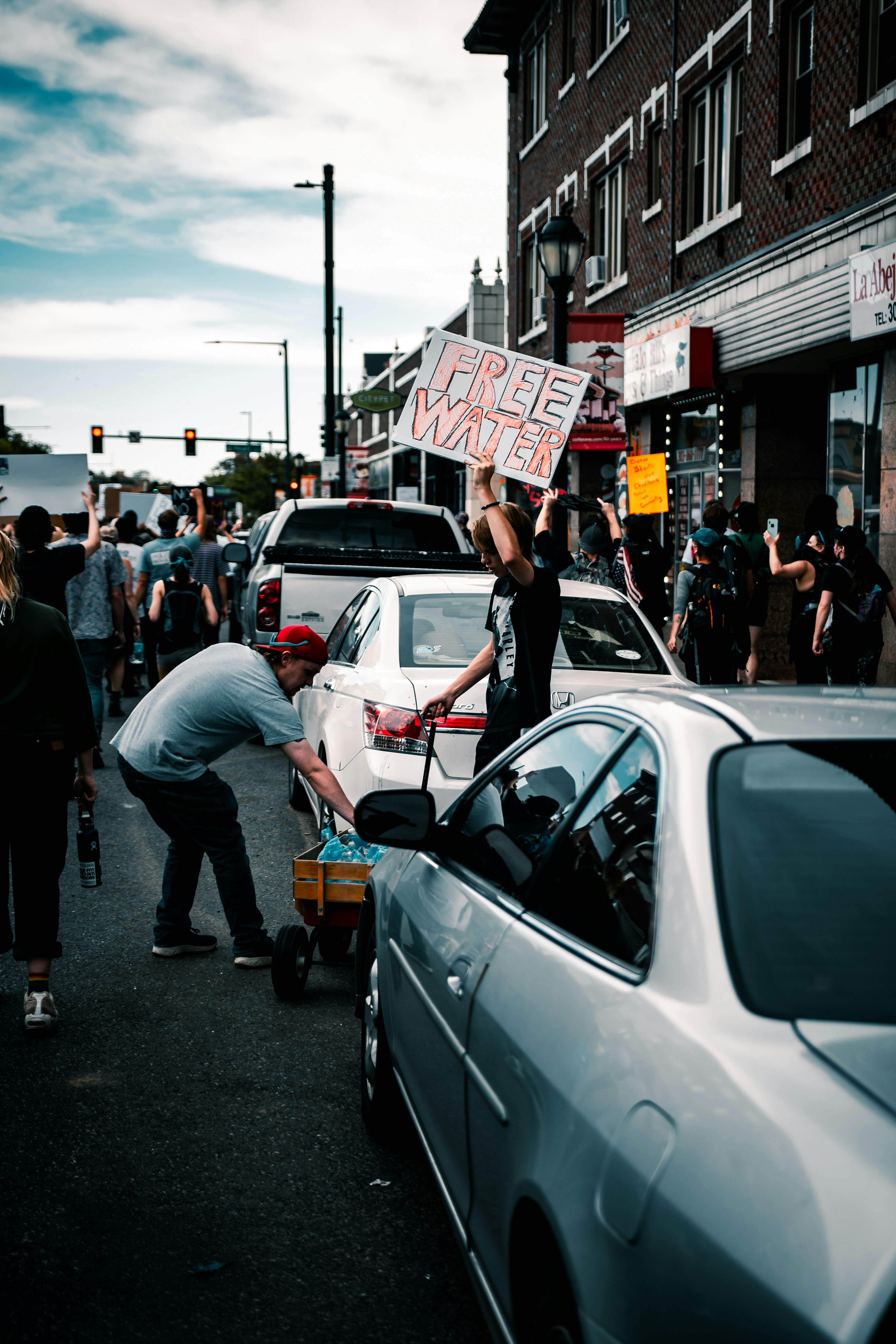 Free Water Tableau: Protesters, Cars, and Signage in a City Street
