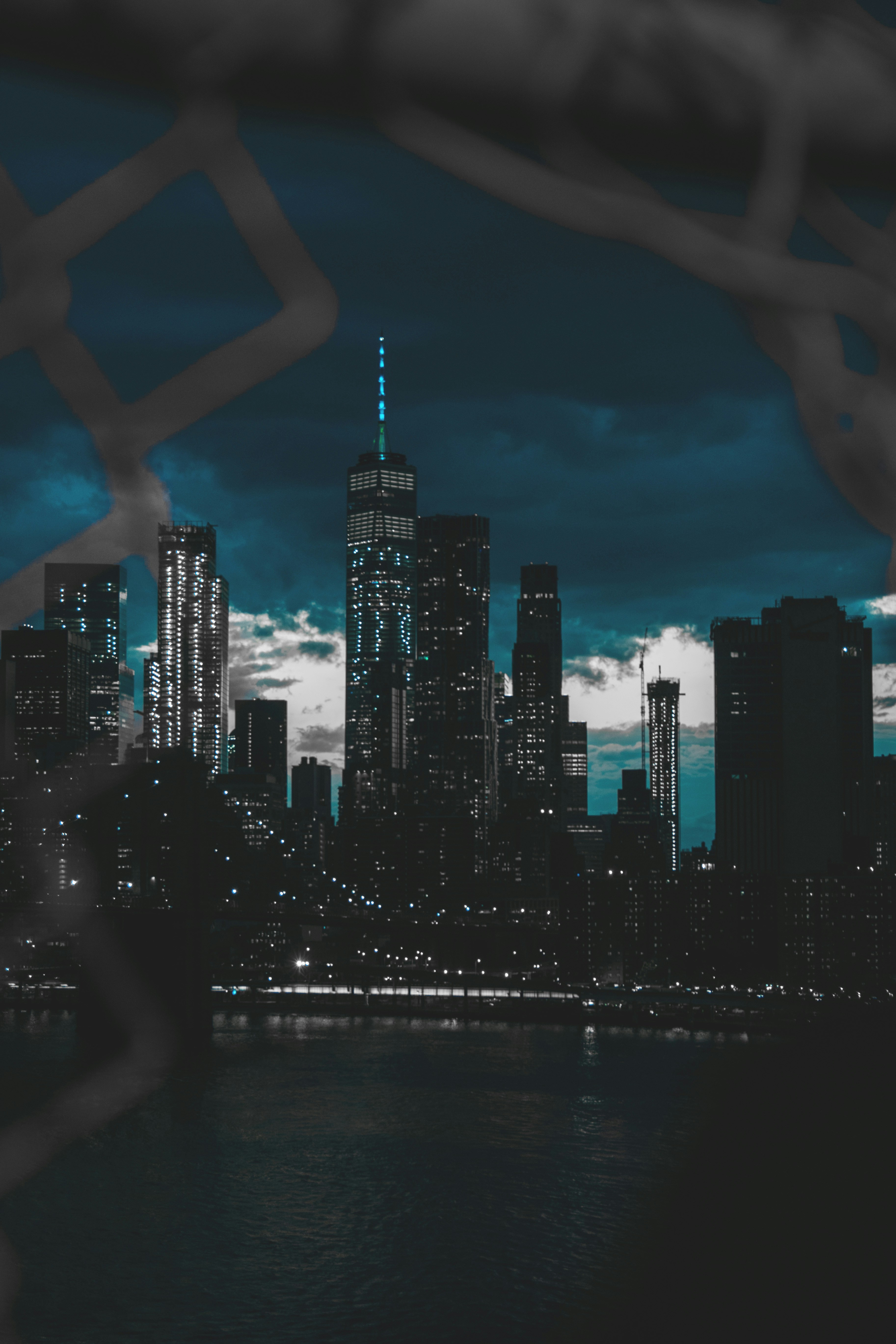 Teal-Soaked Skyline: The Central Tower Pierces a Night-Framed Cityscape