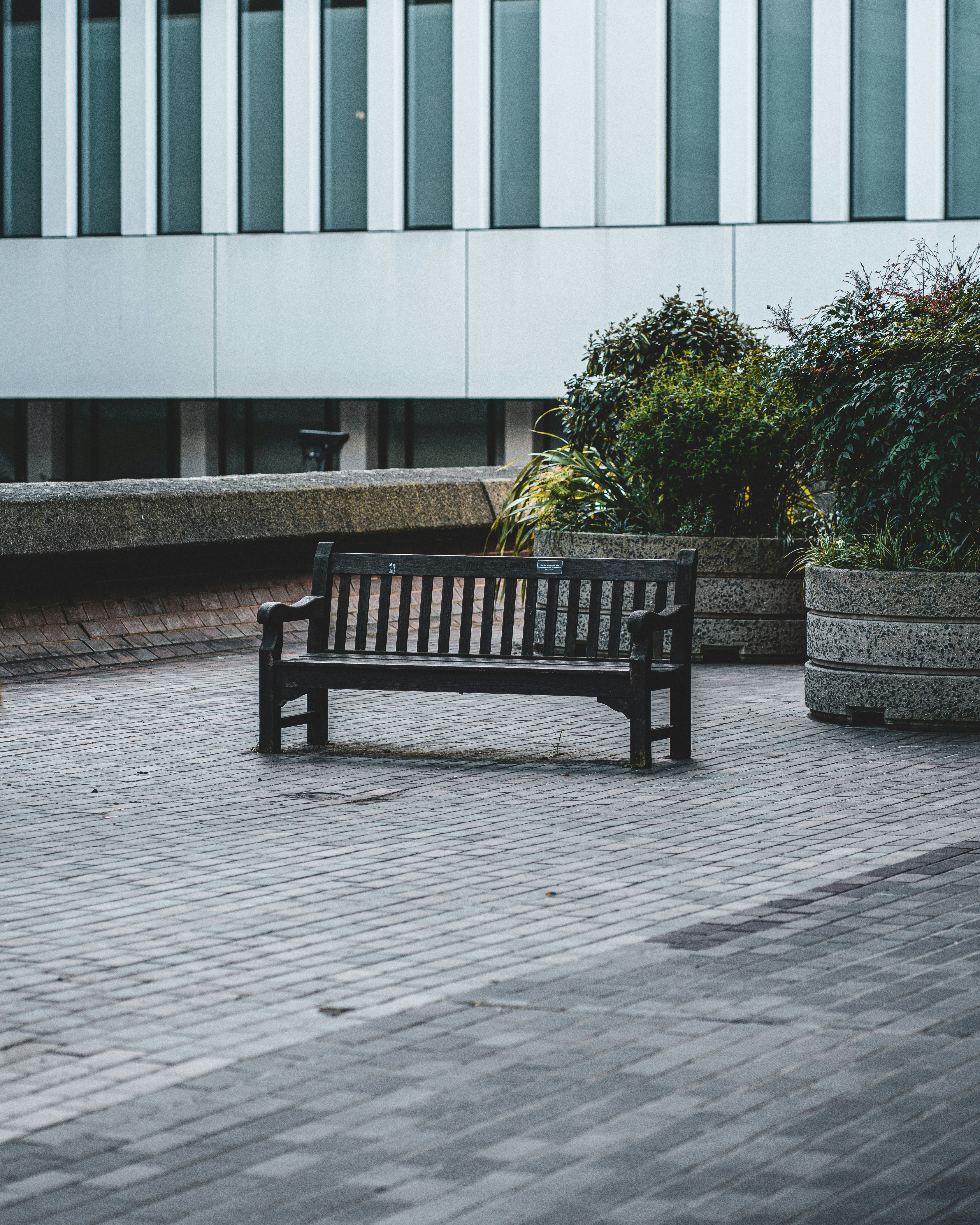 black wooden bench on gray concrete floor