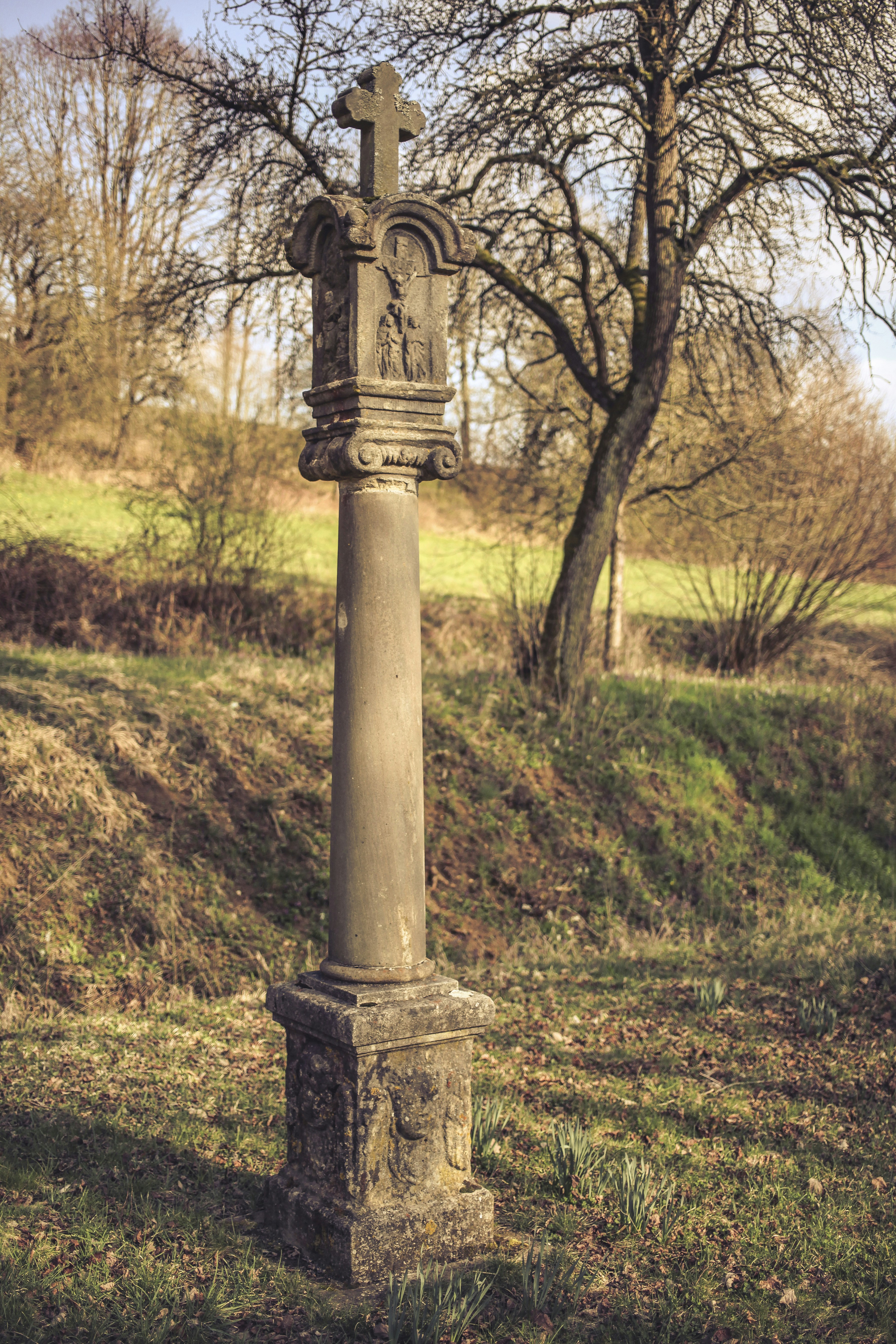 Ancient Shrine on a Weathered Post Amid Quiet Spring Light