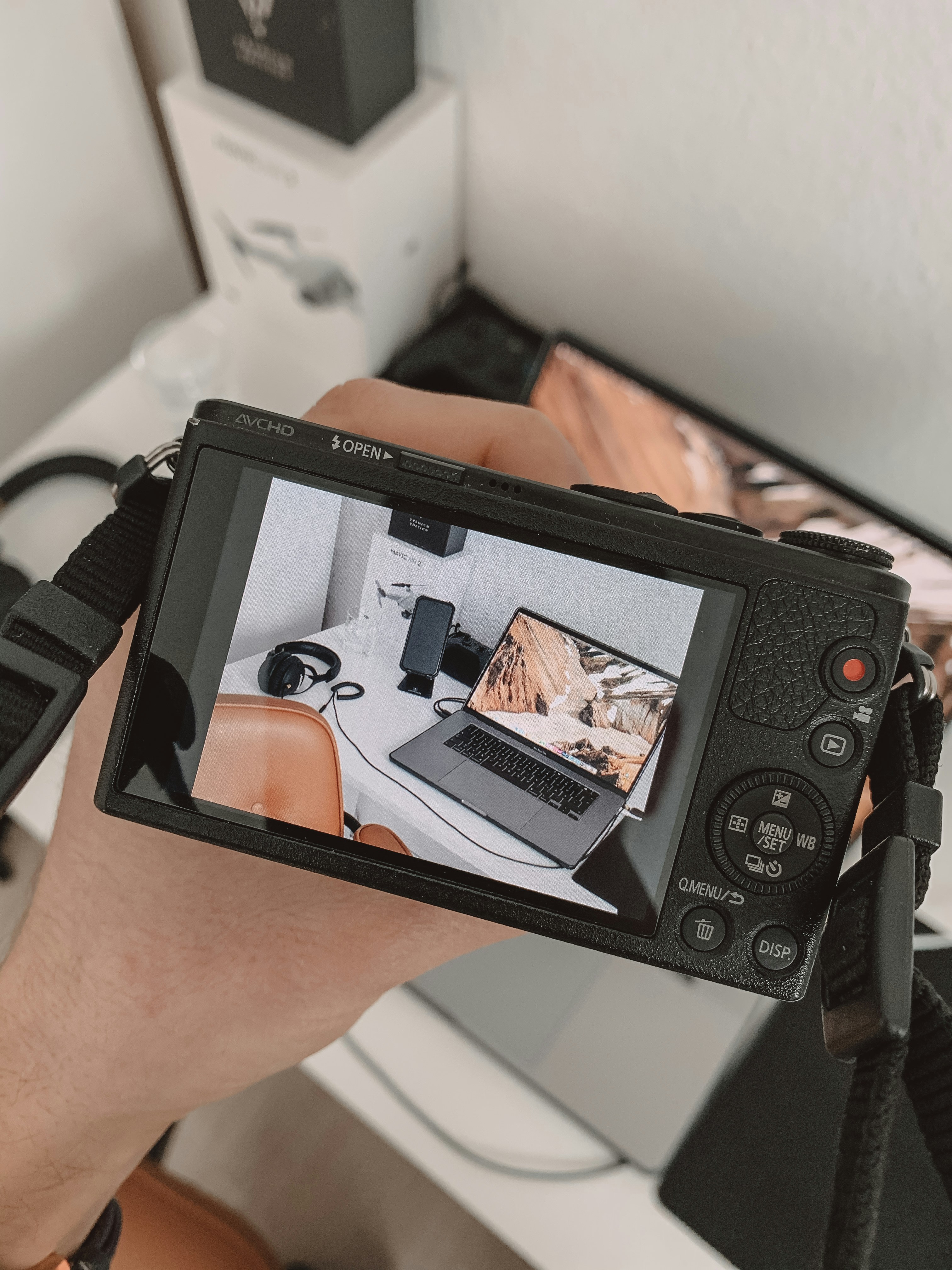 Through the Rear Screen: A Minimal Desk Framed by a Handheld Camera