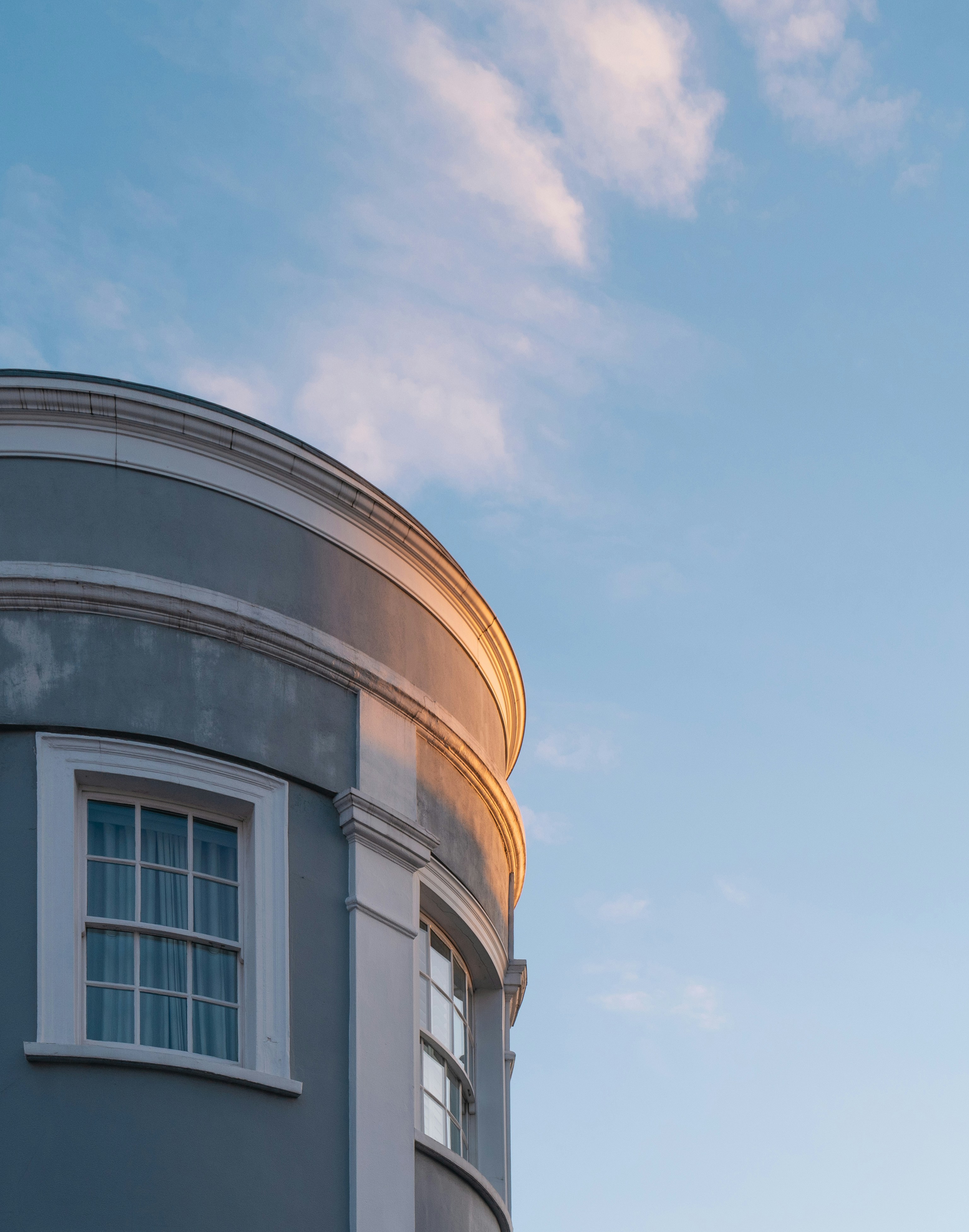 Curved Corner in Quiet Blue: Evening Light on a Classic Facade