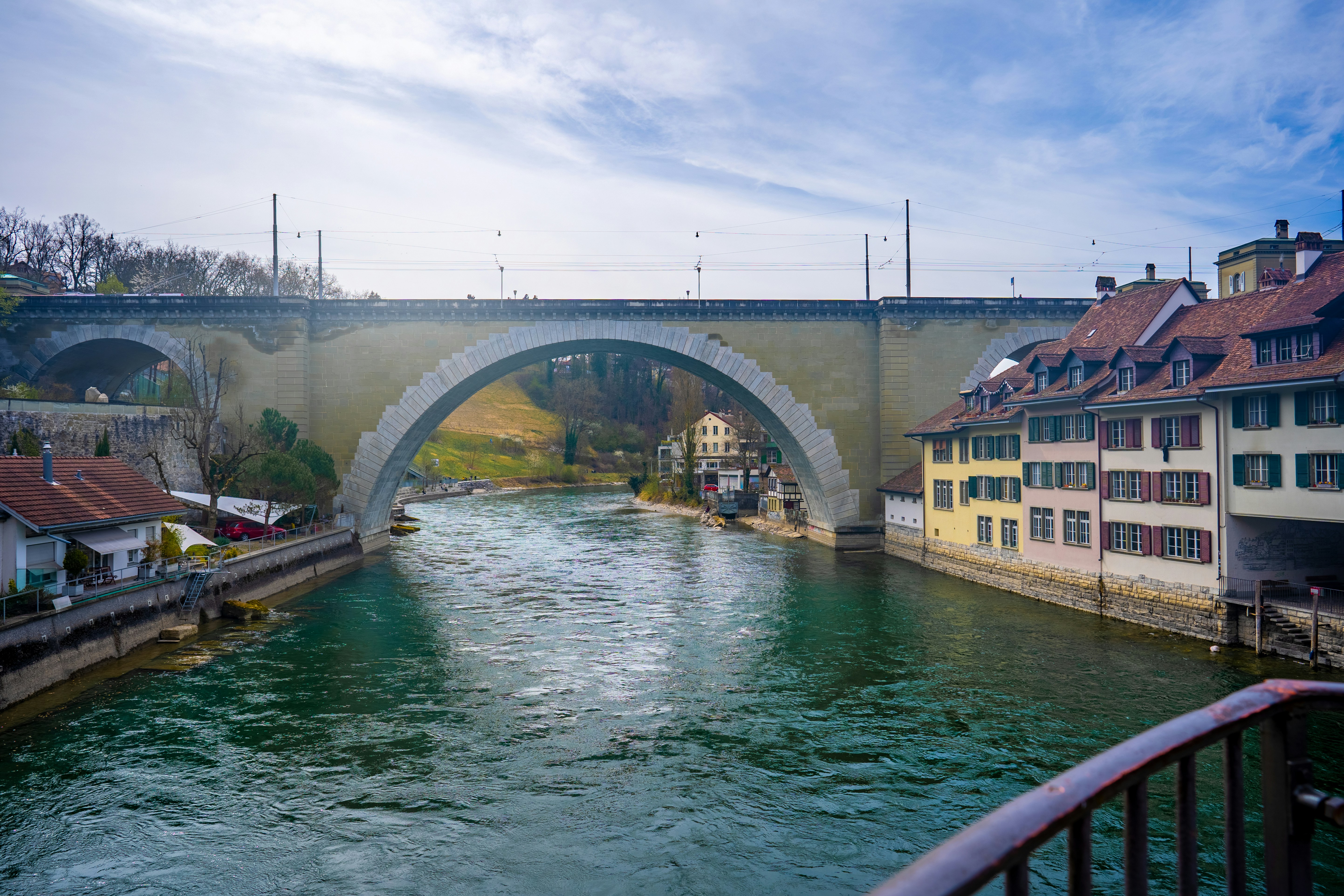White and brown concrete building near bridge under white sky during ...