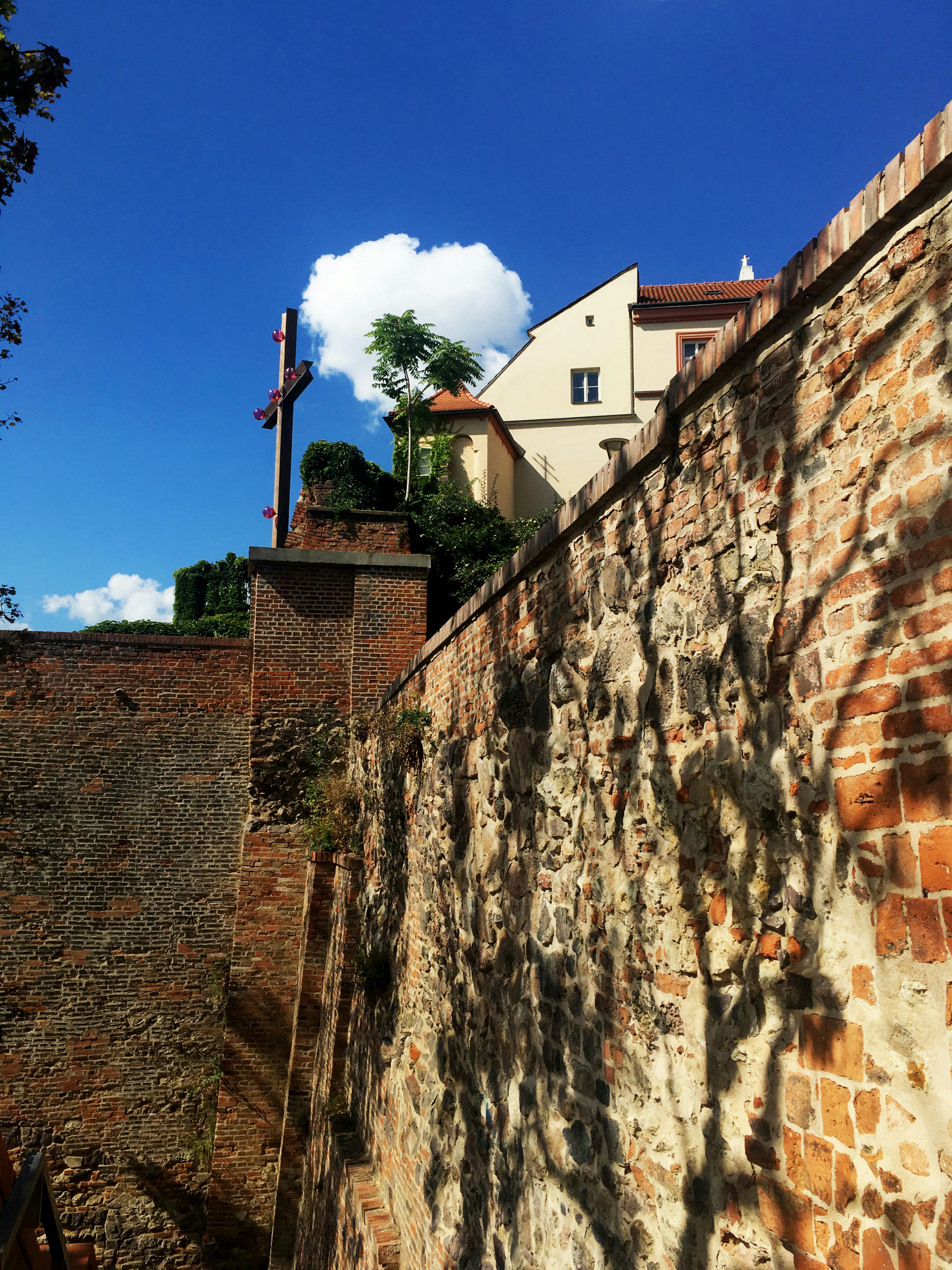 Vertical Wall Mosaic: Sunlit Brick and Stone Against a Clear Sky