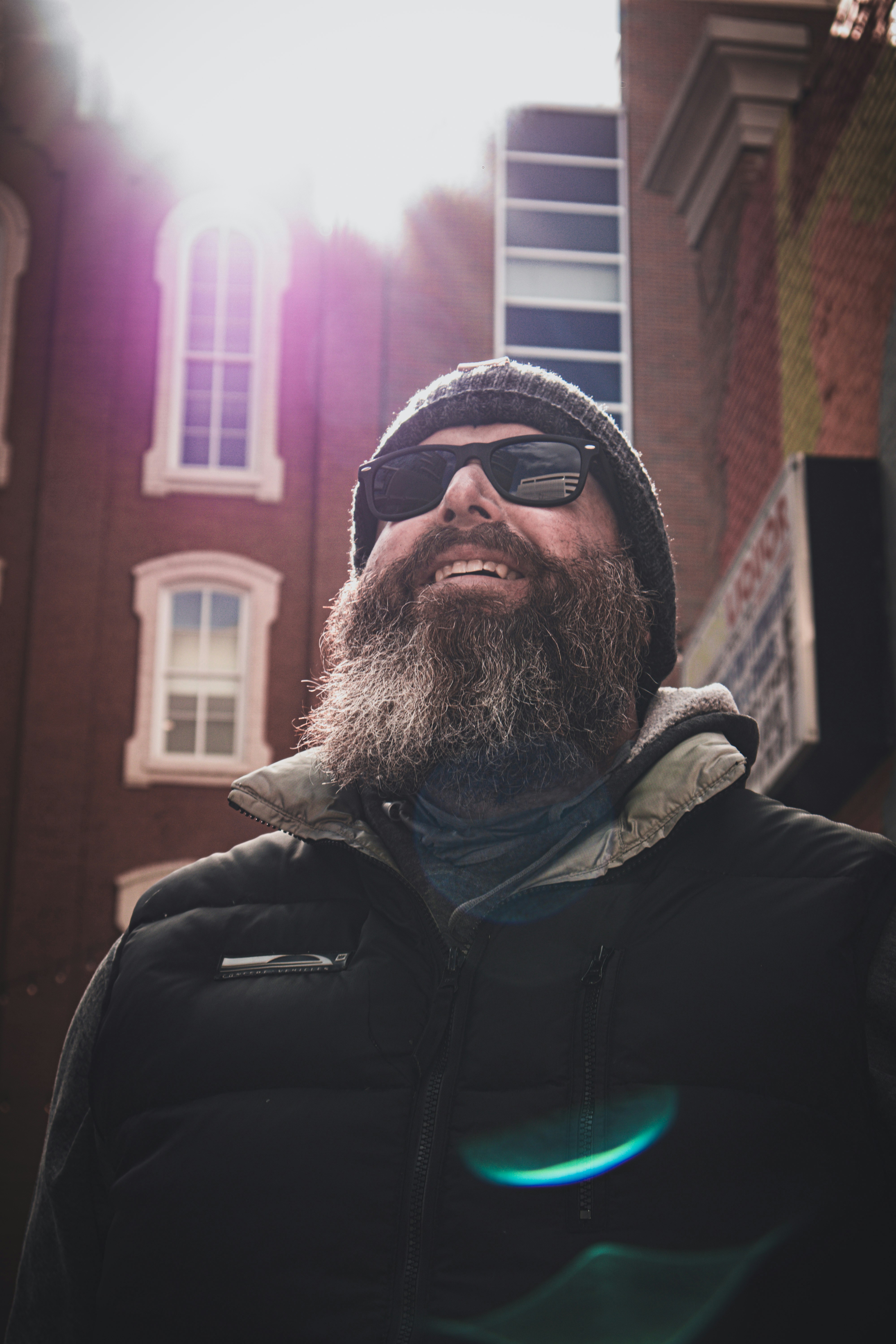 Sunlit Bearded Portrait in an Urban Brick-and-Glass Morning