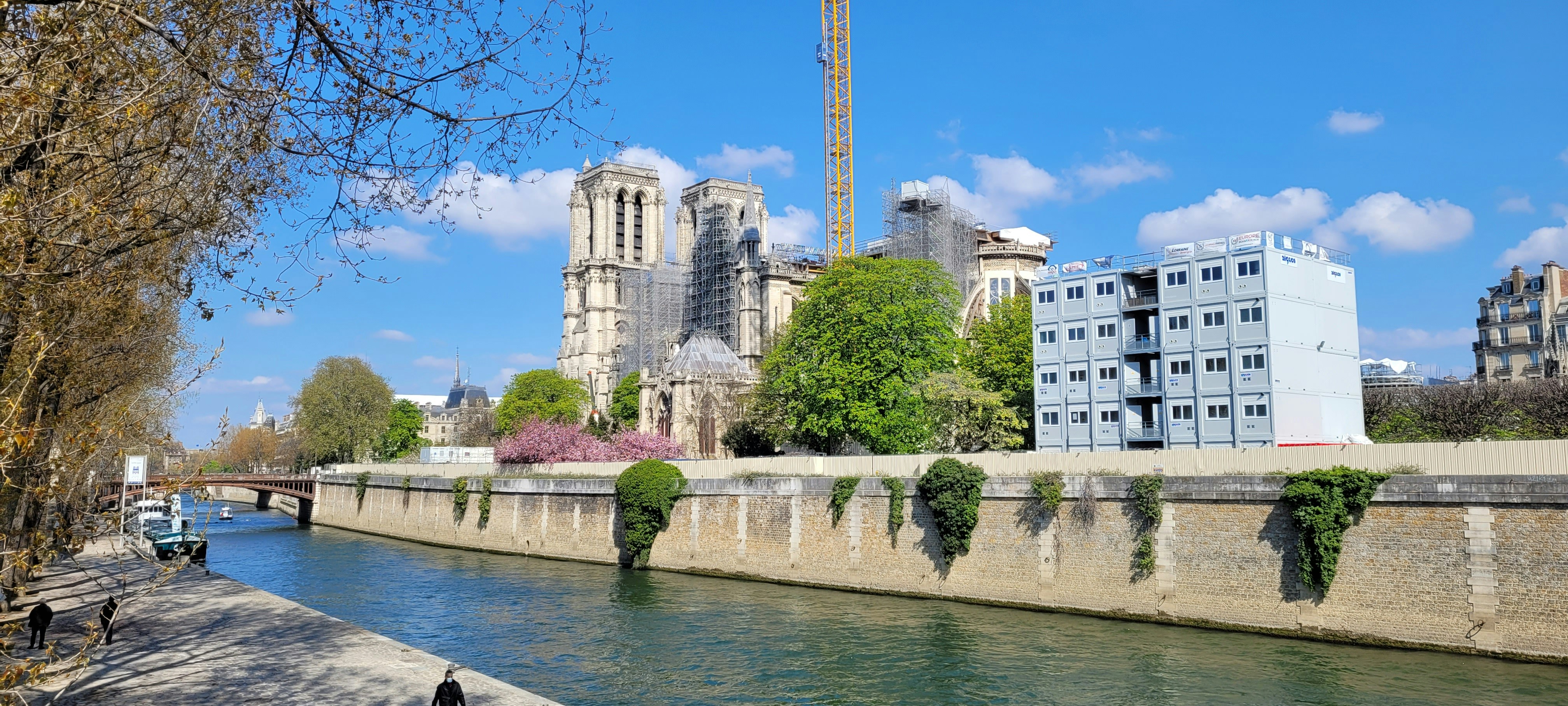Crane Over Notre-Dame: Restoration Amid the Seine's Calm