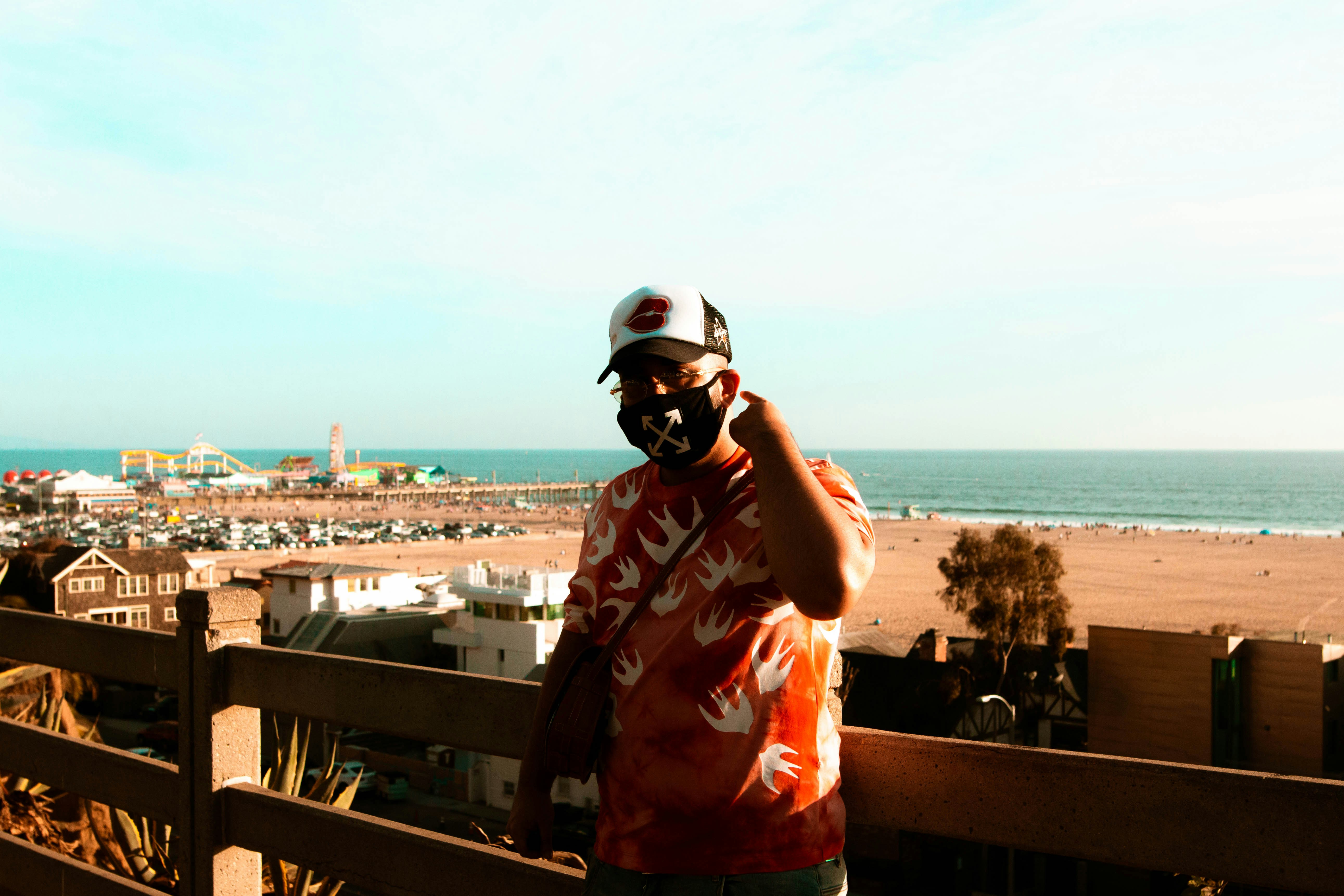 Palm-Patterned Portrait on a Sunlit Beachfront Boardwalk