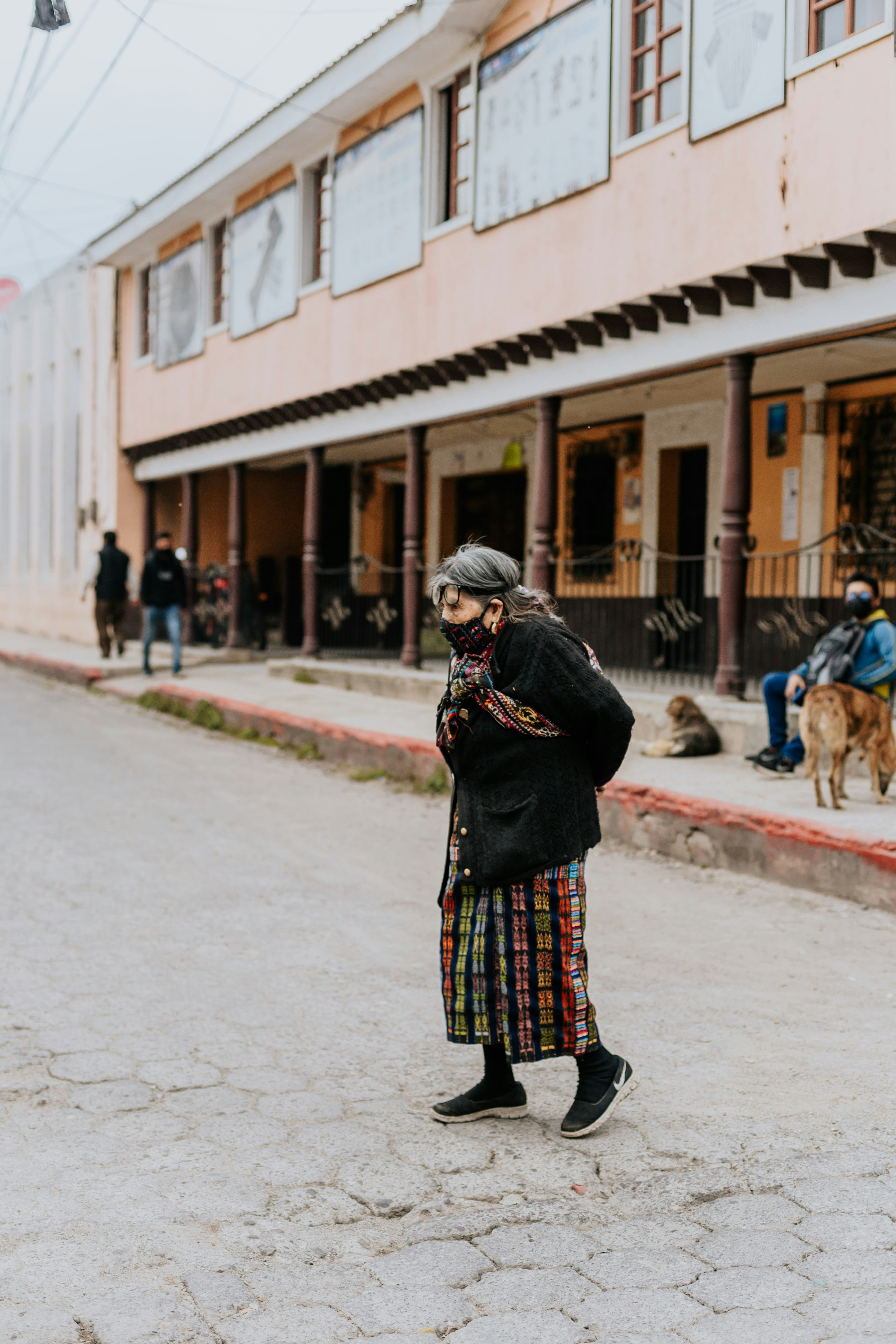 Traveler in a Colorful Skirt Crossing a Quiet Street